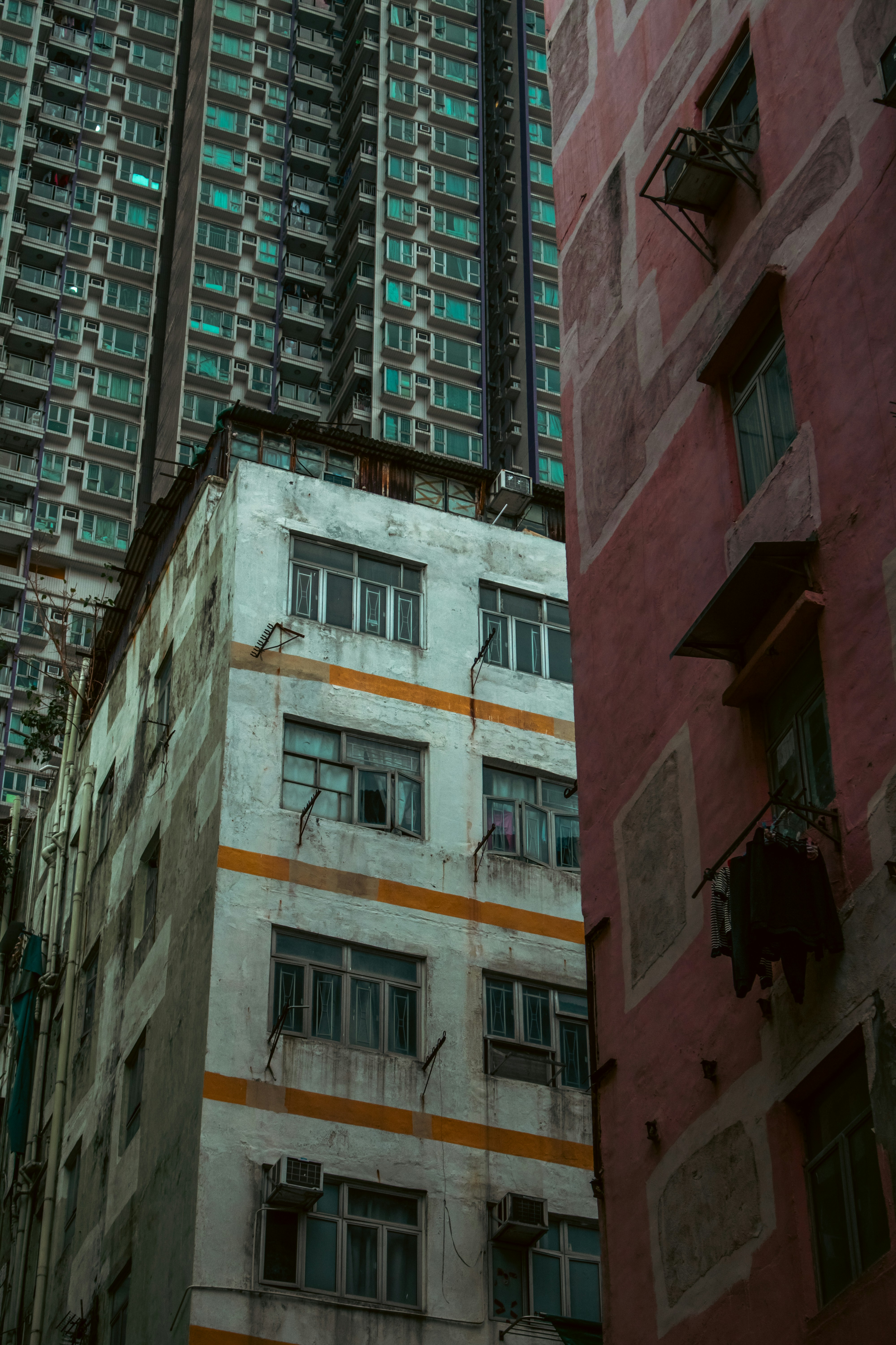 Between Concrete Strata: a Narrow Veil of Color Amid Towering Facades
