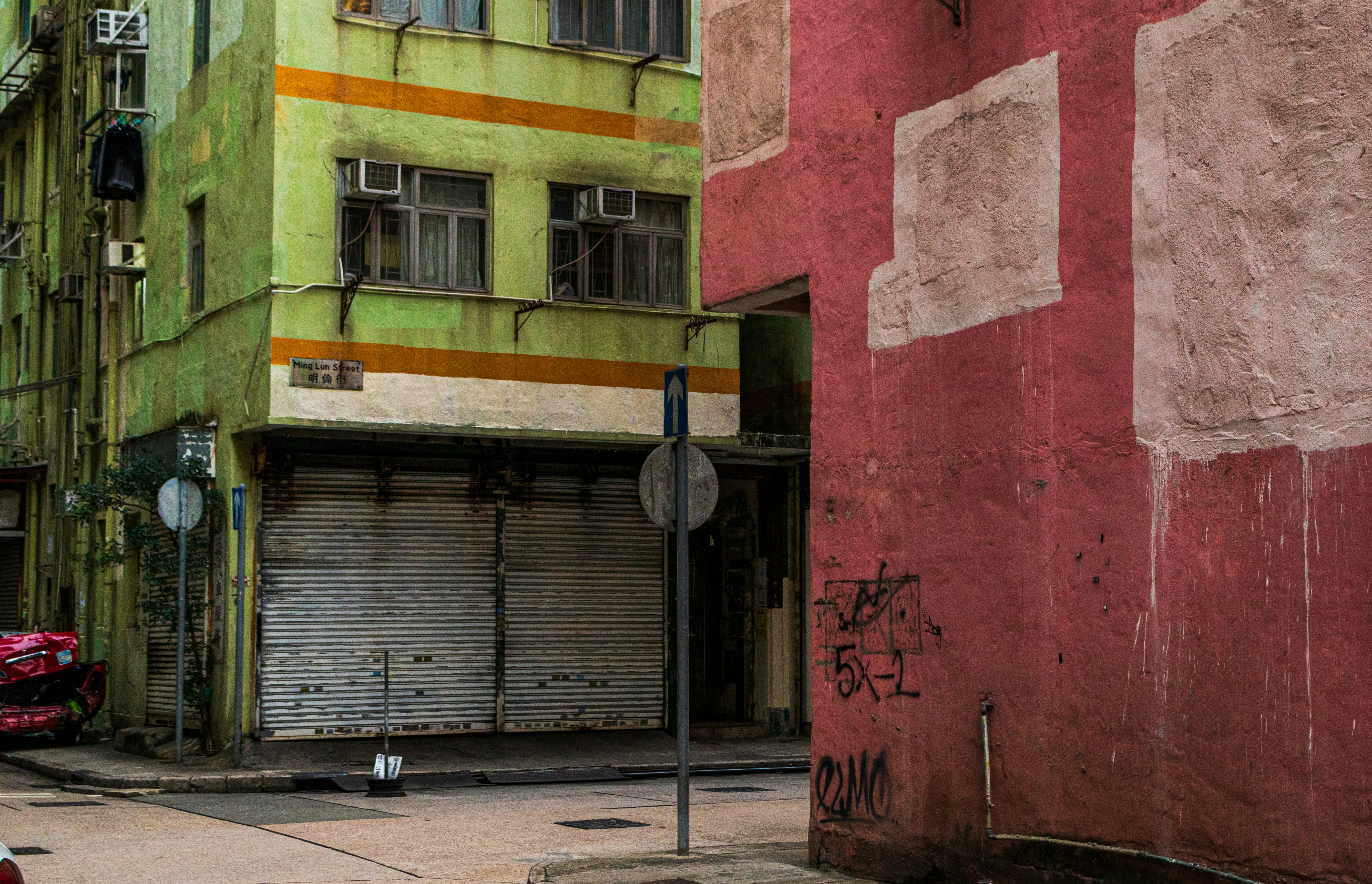 Neon Facades and Closed Storefronts in a Colorful Urban Alley