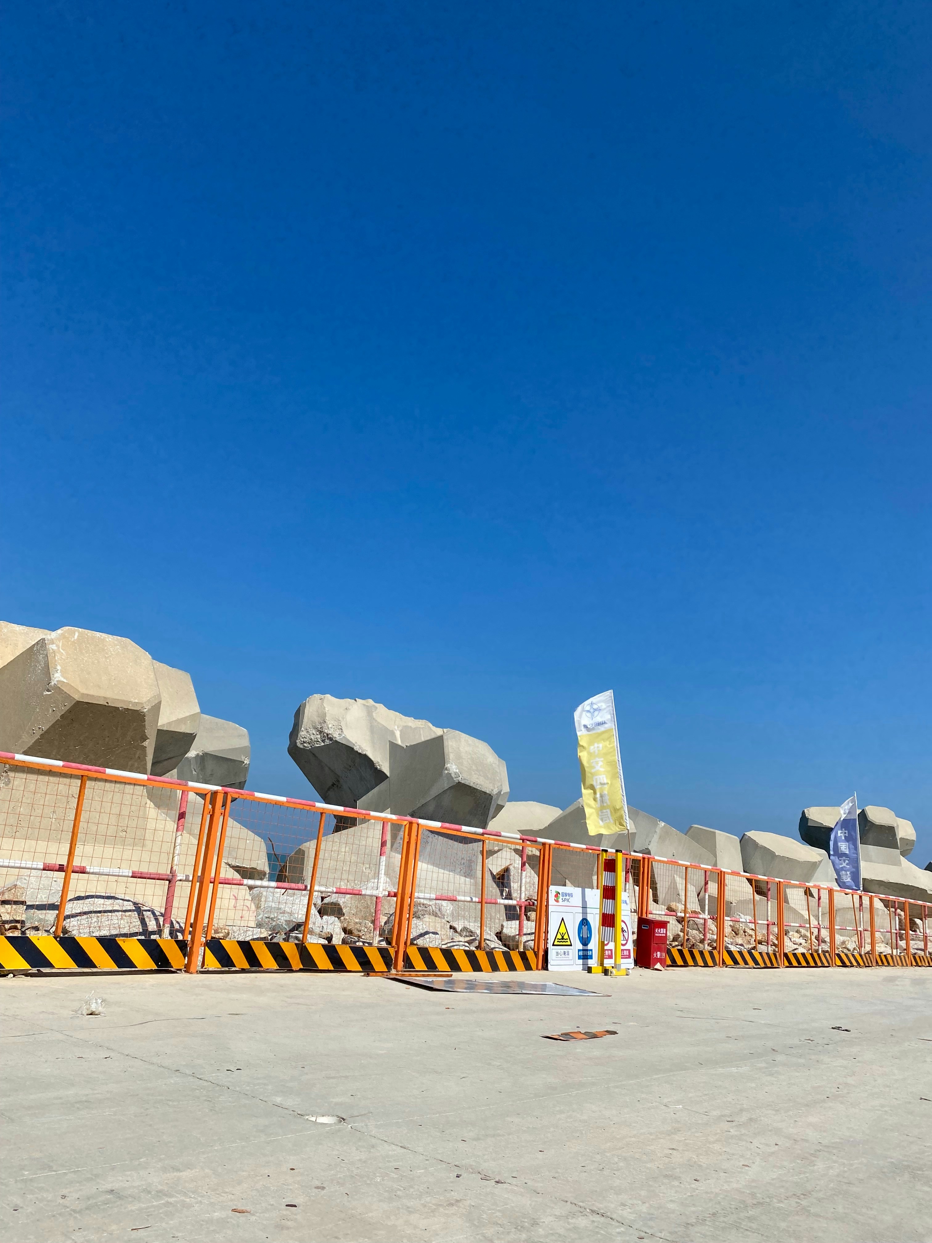 Blue Sky Over a Concrete Breakwater Construction Zone