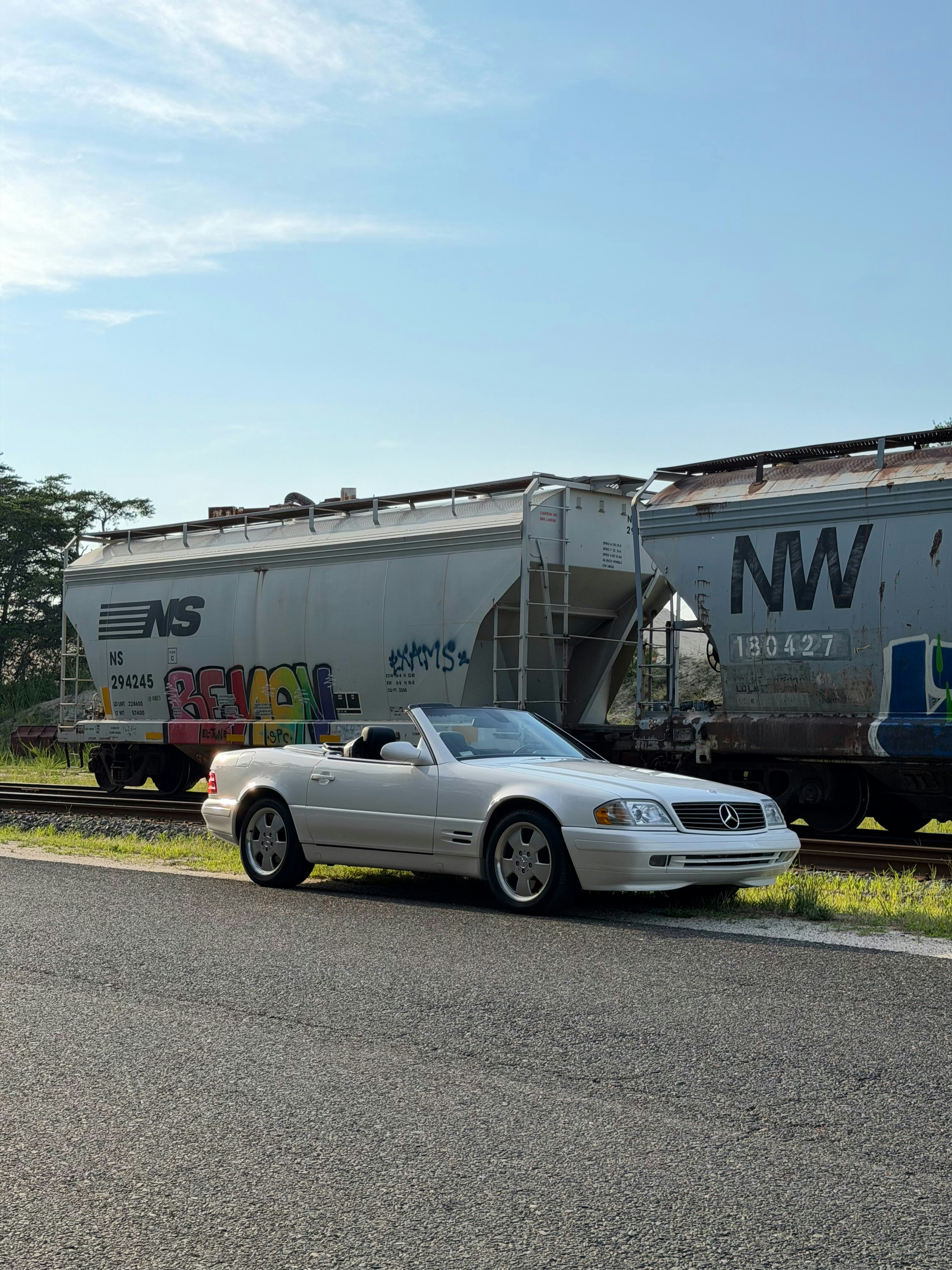 White Convertible on Rails: A Quiet Moment by Graffiti Freight