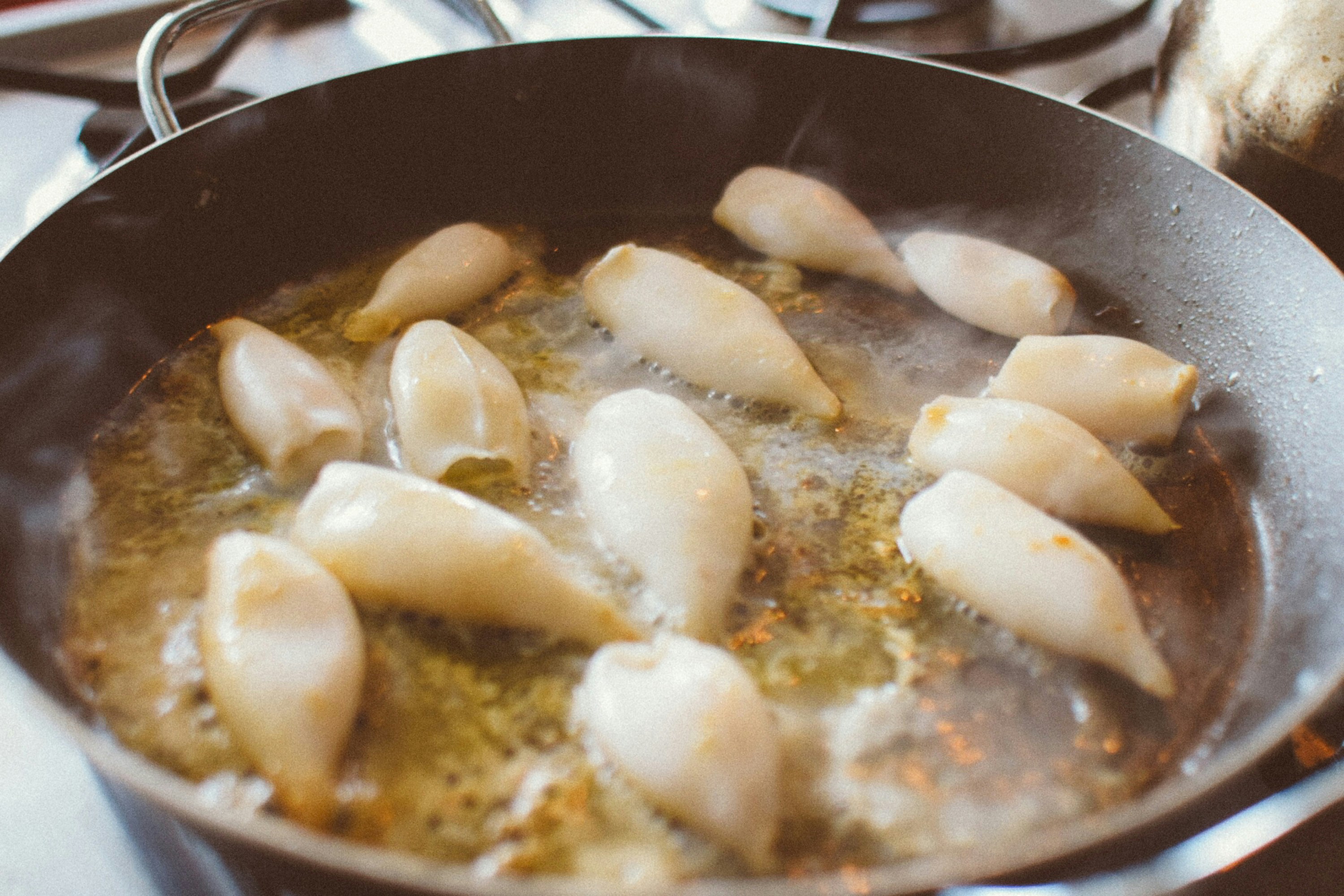 Golden Dumplings Sizzling in Buttered Pan
