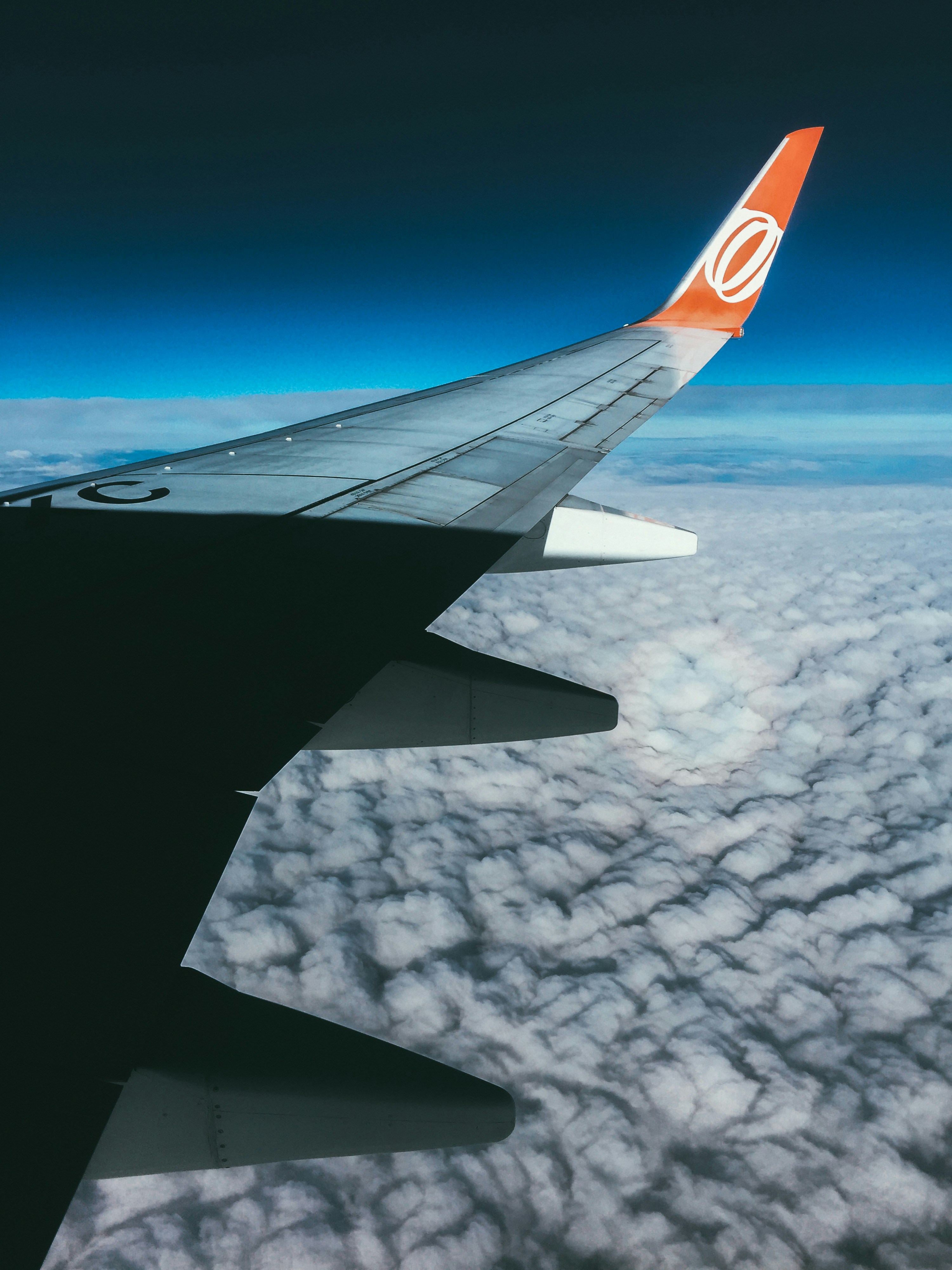 Wingtip in the Blue: Aerial View Above Clouds from an Airliner