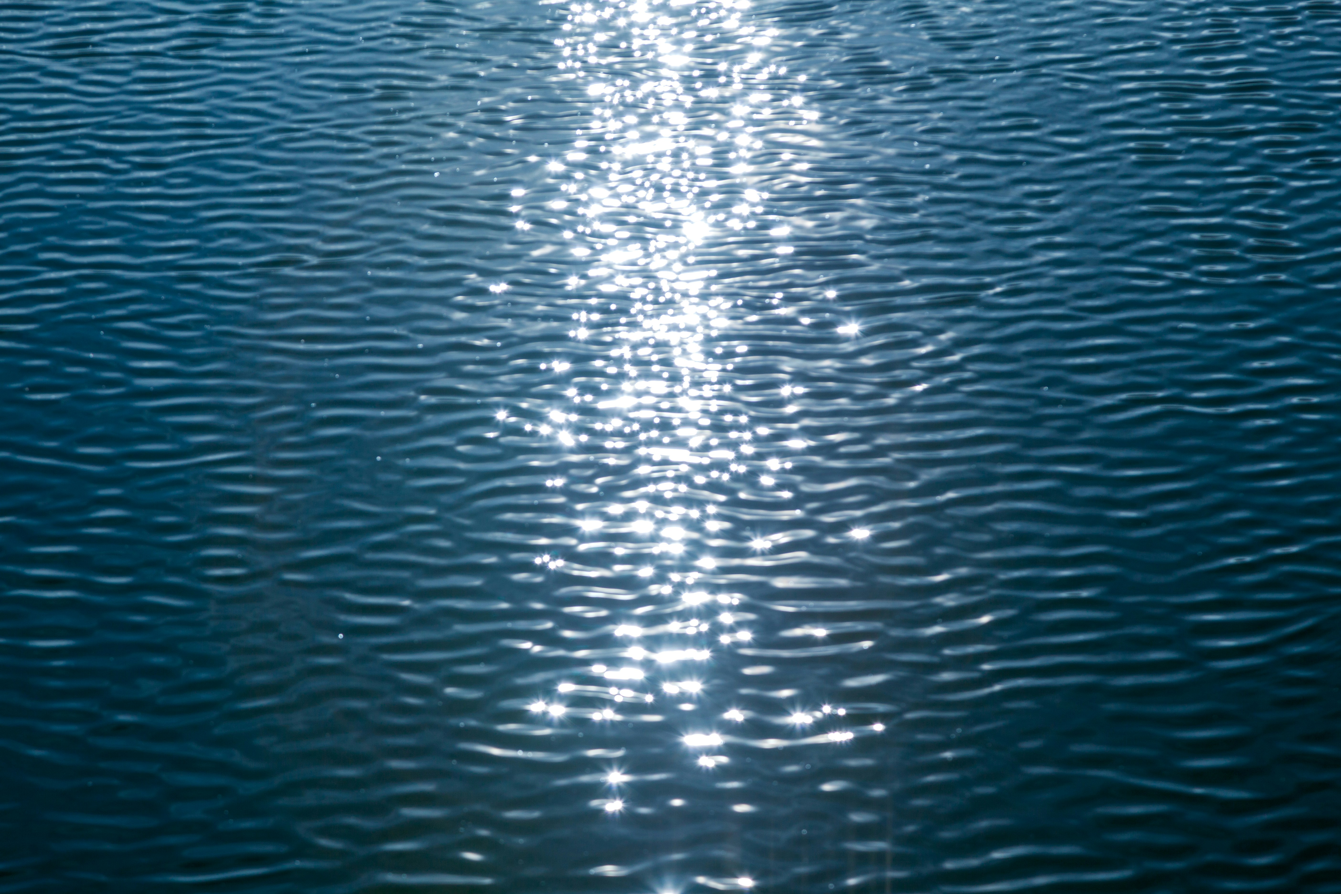 Glittering Ripple Path: Sunlit Stripes Across Quiet Blue Water