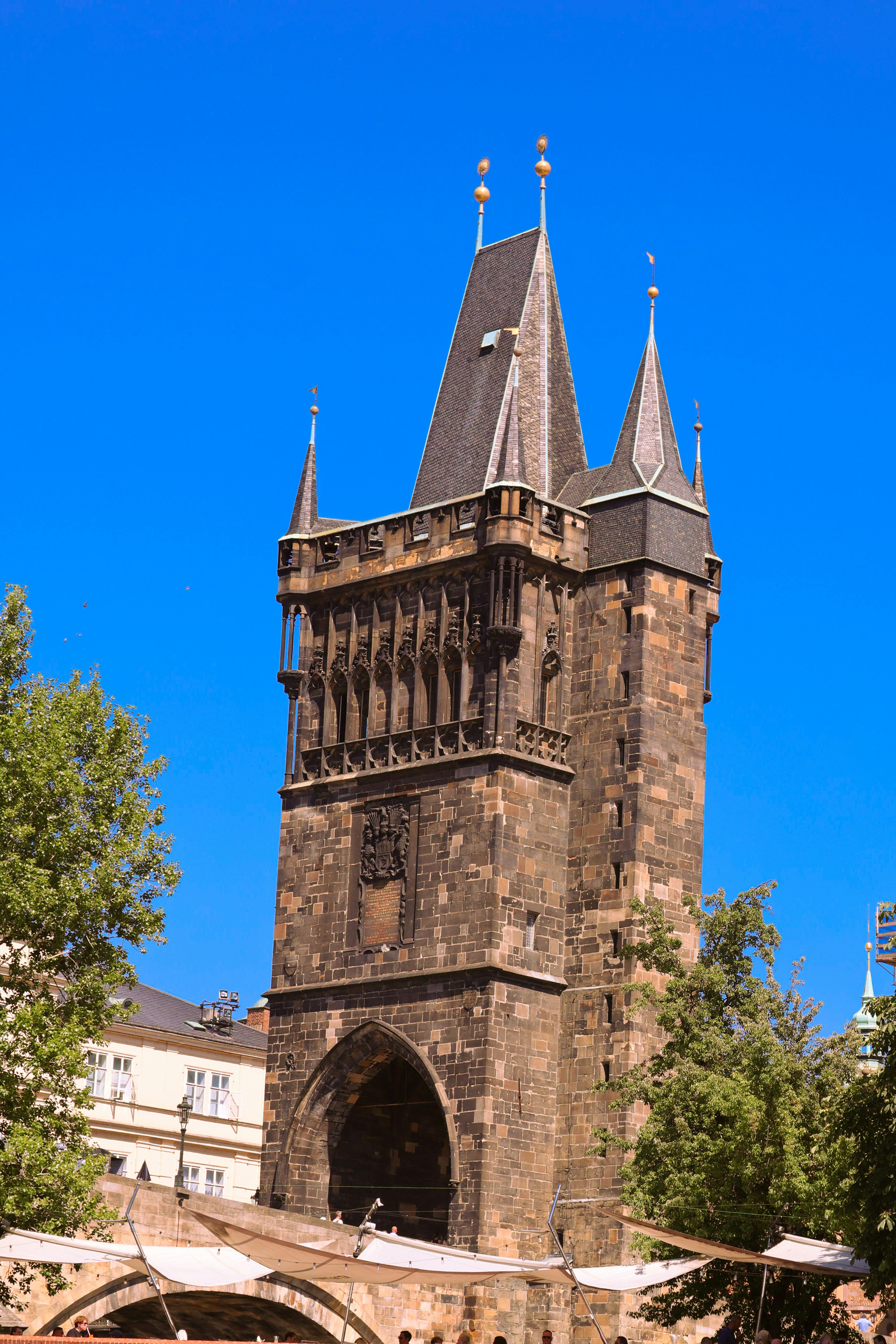 Towering Crest: Medieval Gatehouse Against a Pristine Blue Sky