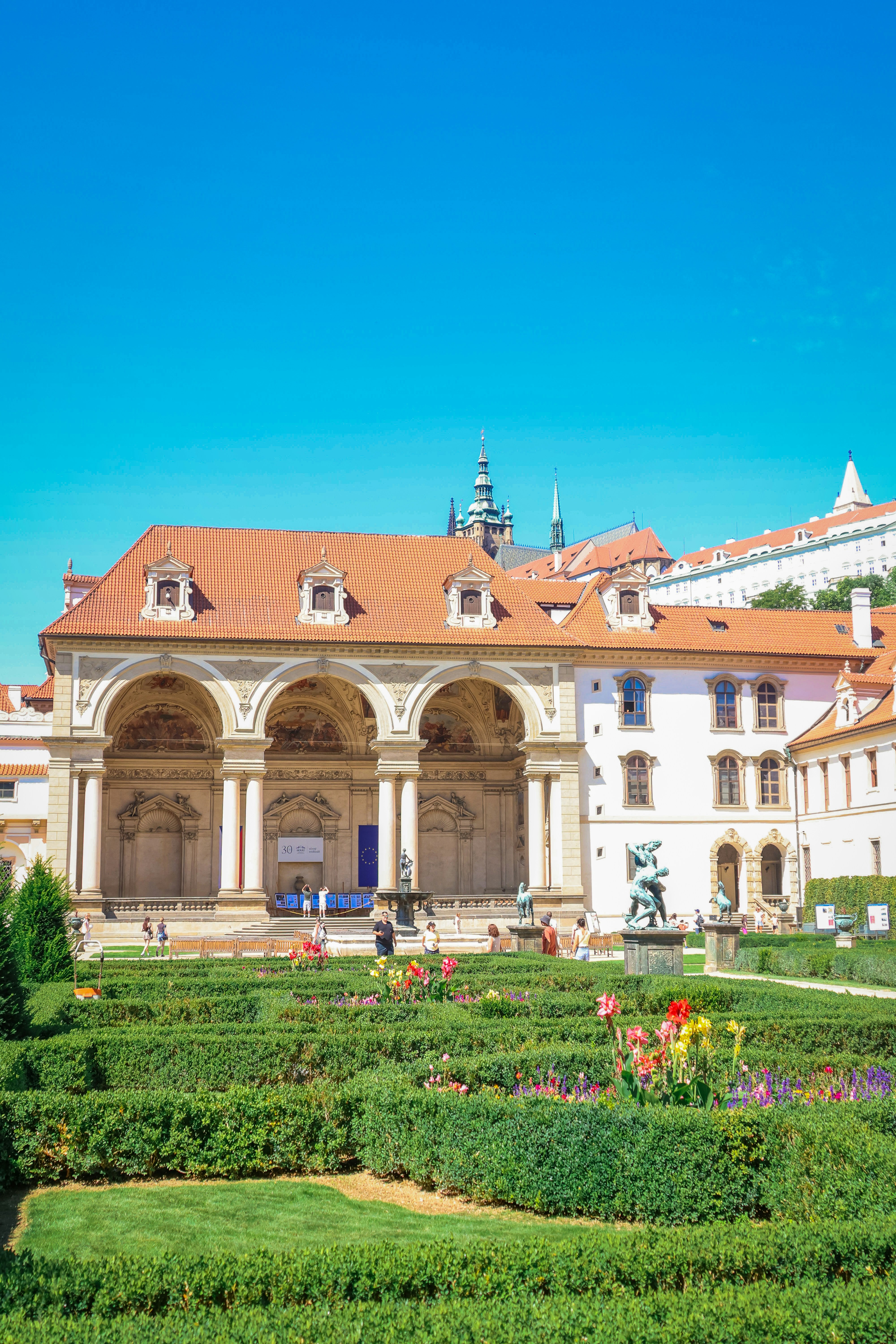 Arched Courtyard Crowned by Red Tile and Green Parterres