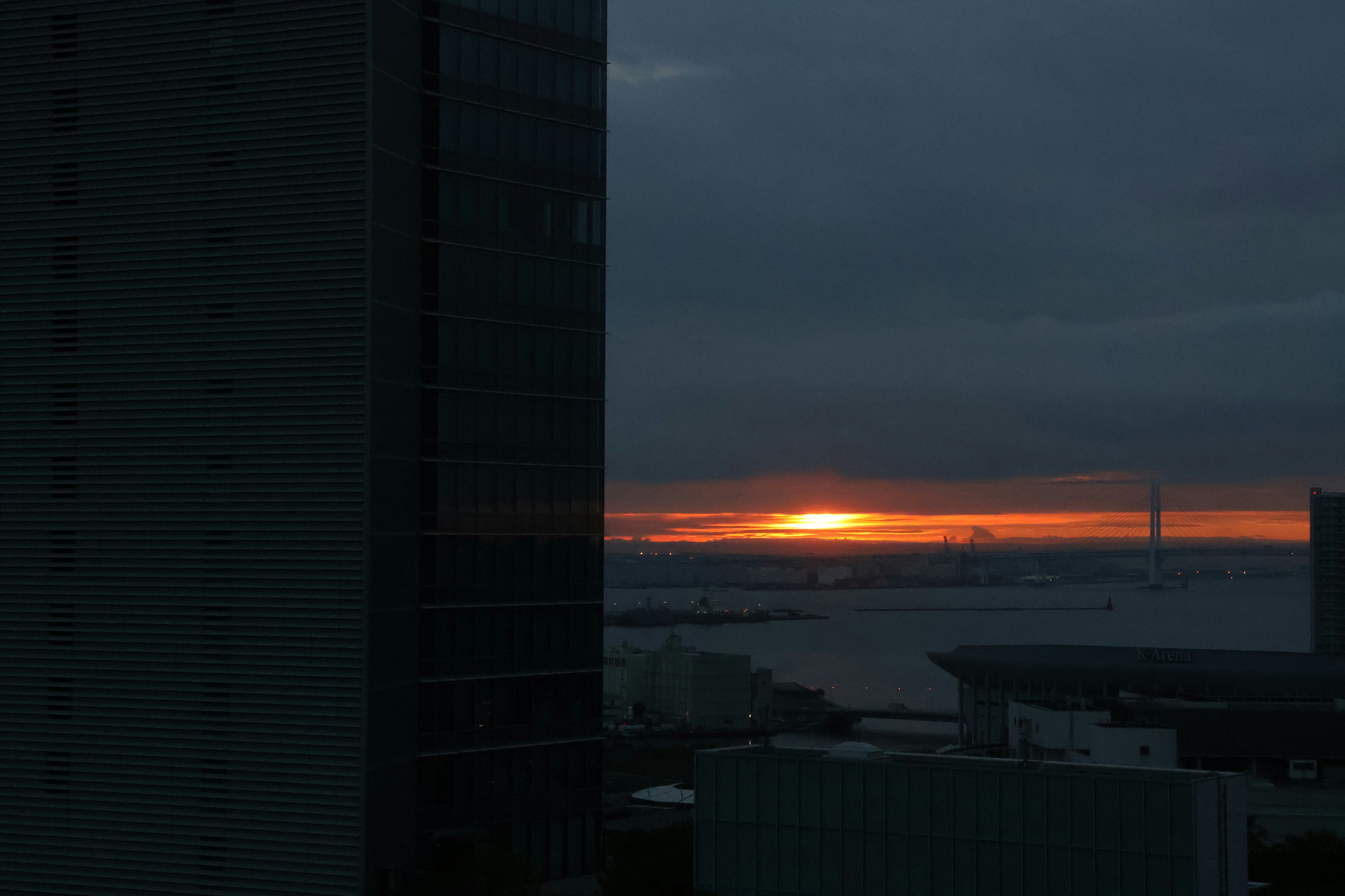 Sun Pier at Dusk: A City Silhouette Basks in Low Light