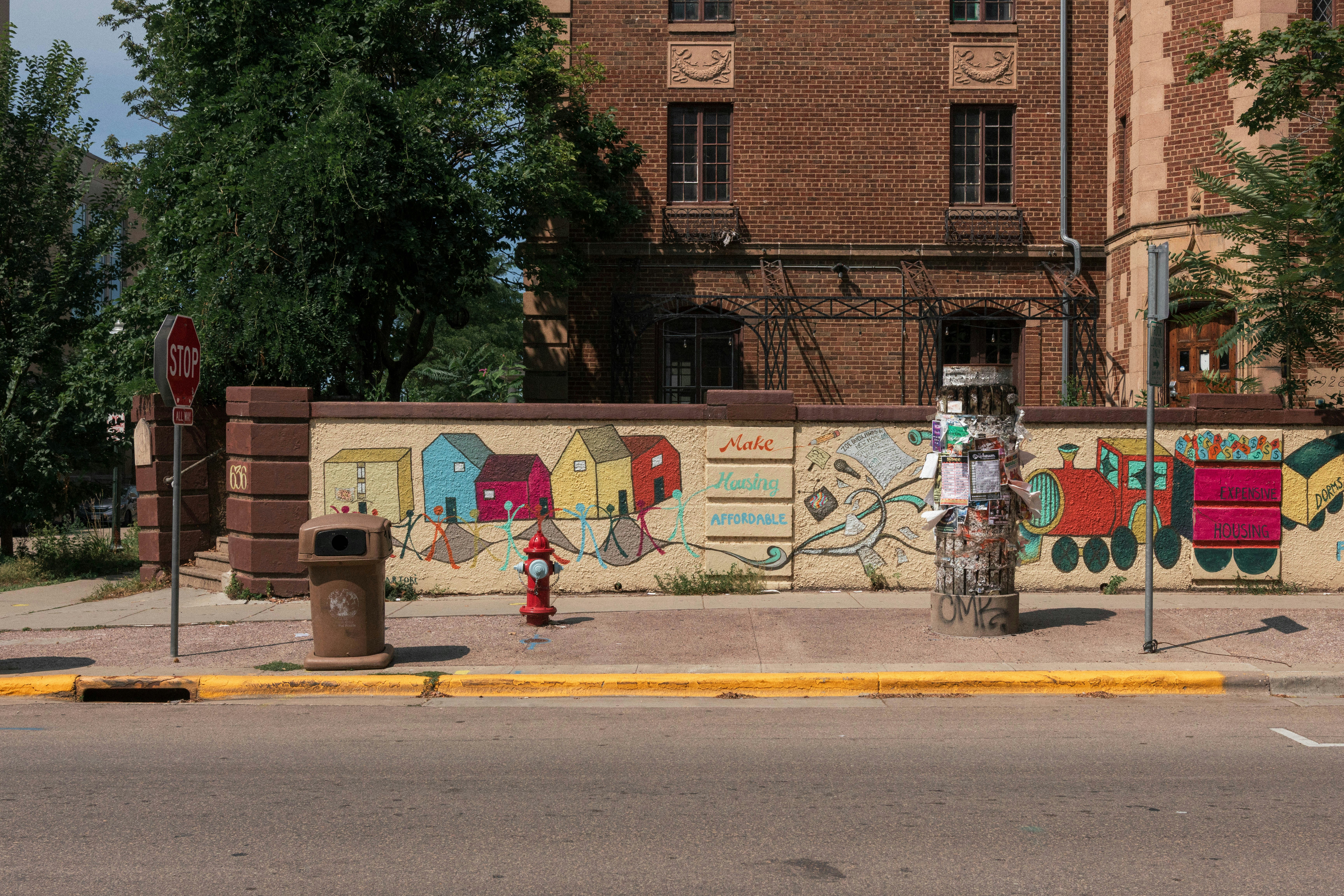 Colorful mural and brick building behind a quiet street