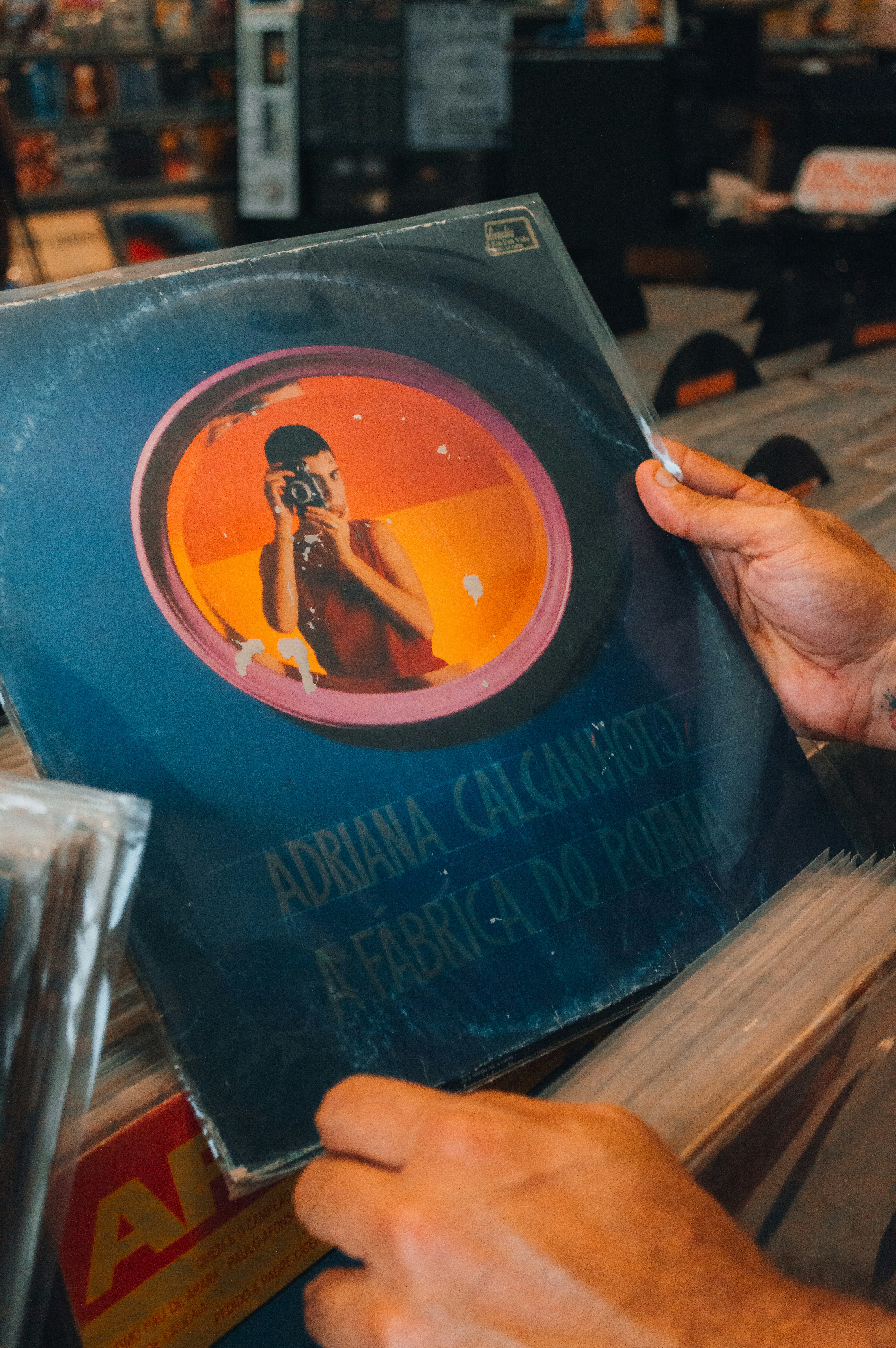 Vinyl in Focus: A Record Shop Moment through a Gripping Perspective