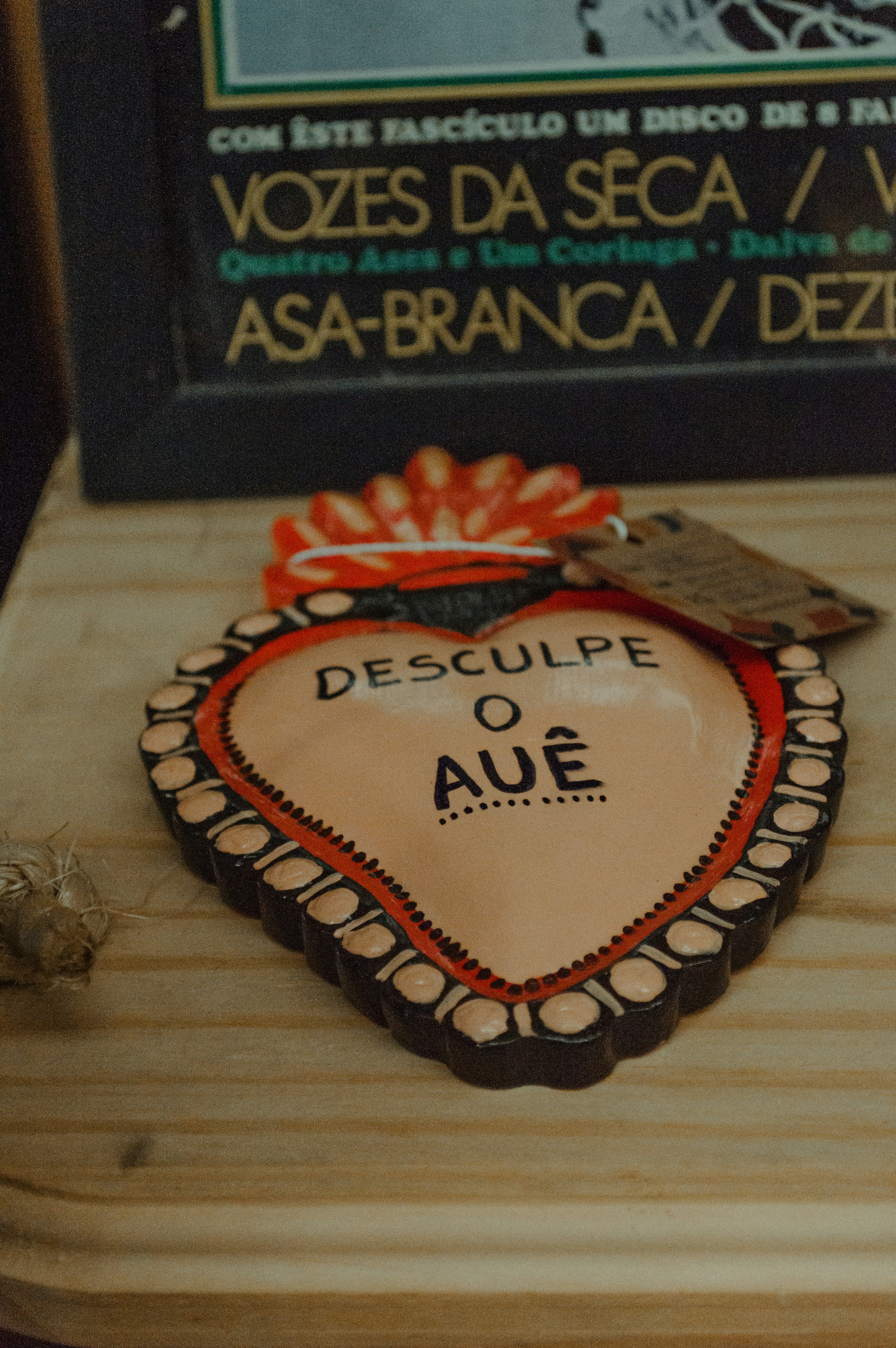 Love Token on a Rustic Table: Heart-Shaped Keepsake and Framed Memorabilia