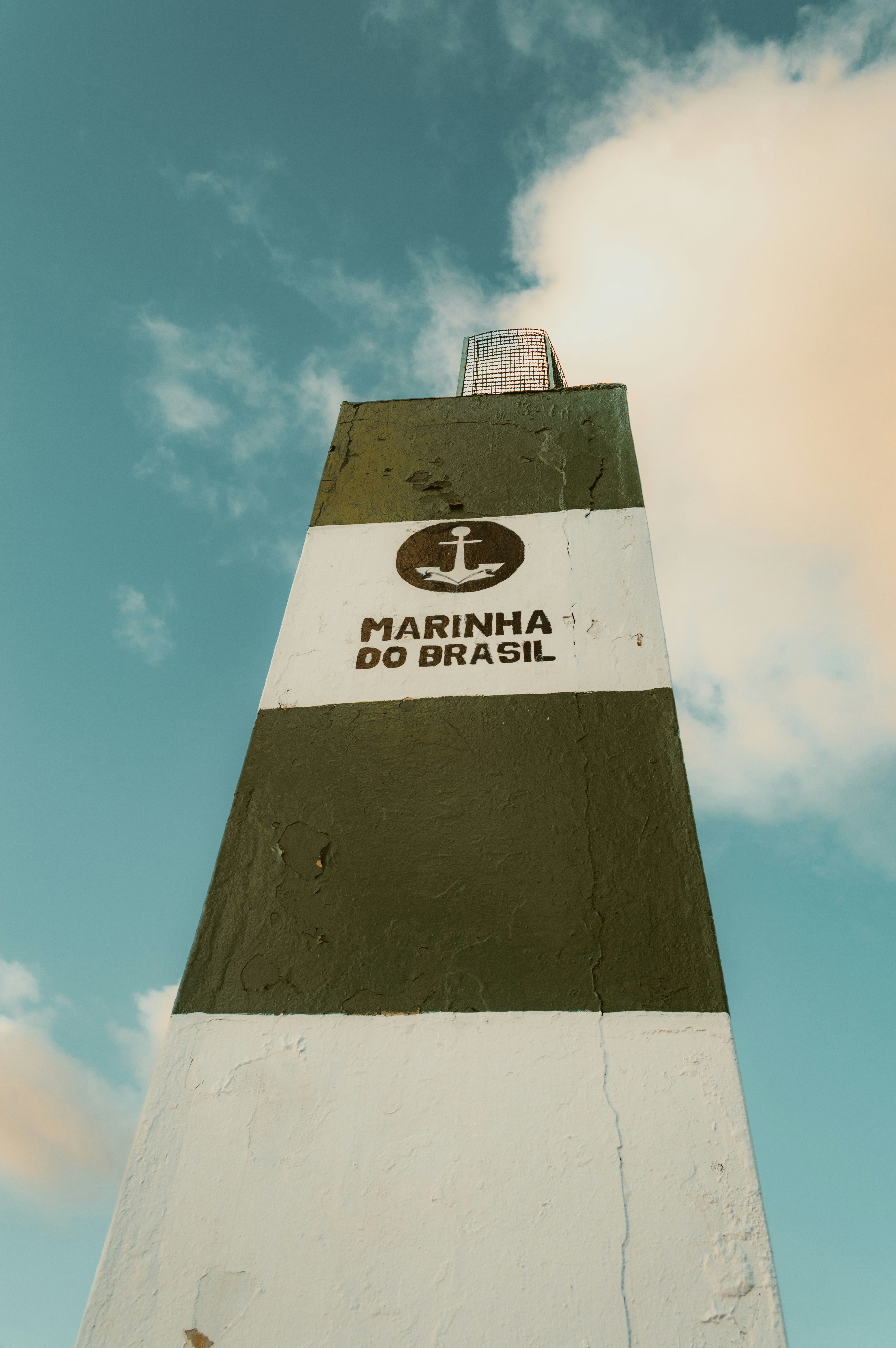 Anchor of the Sea: Striped Lighthouse Reaching Toward the Sky