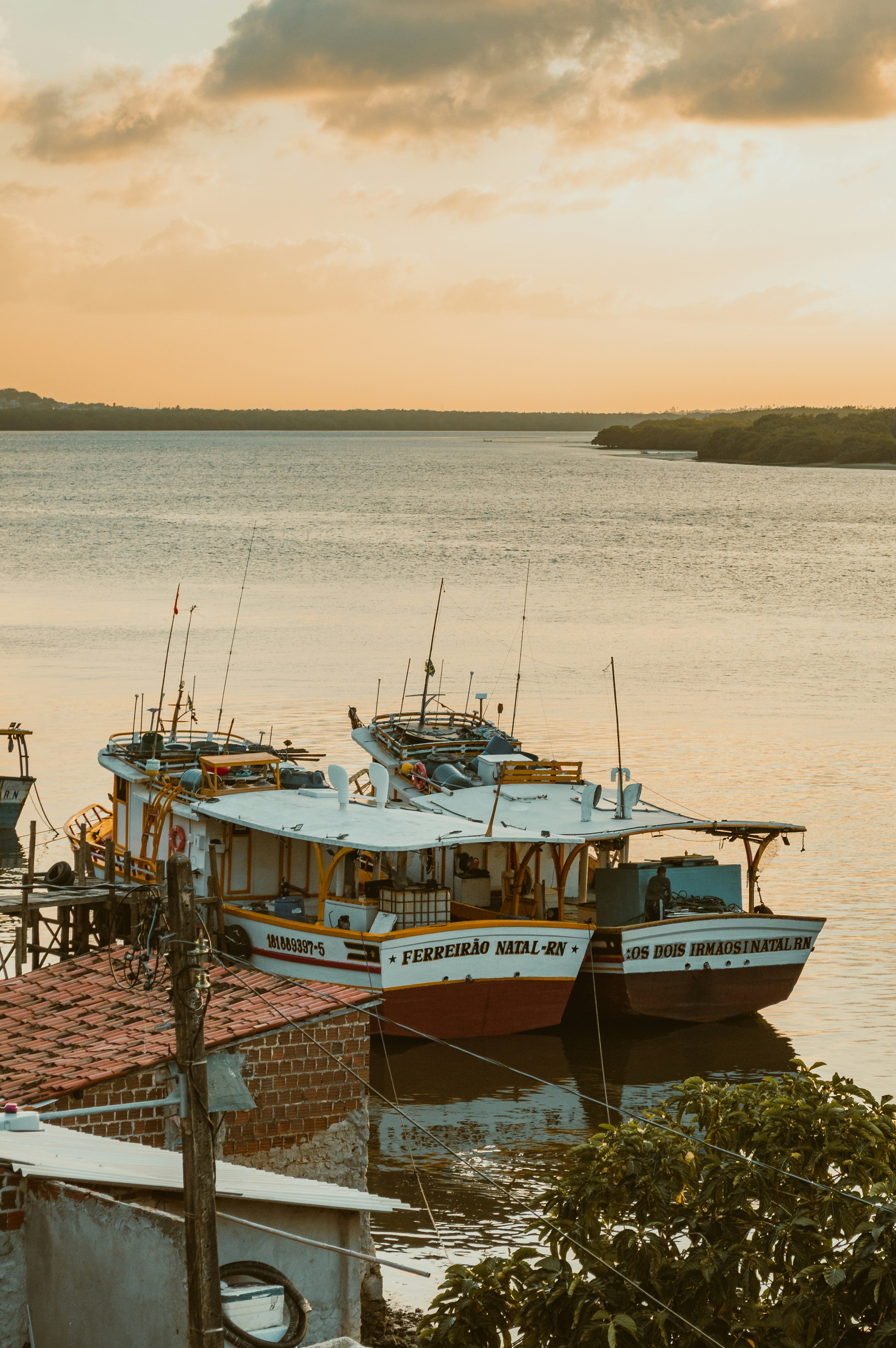 Sunlit Docks: Boats Lined Along the Riverside in Dusk Glow