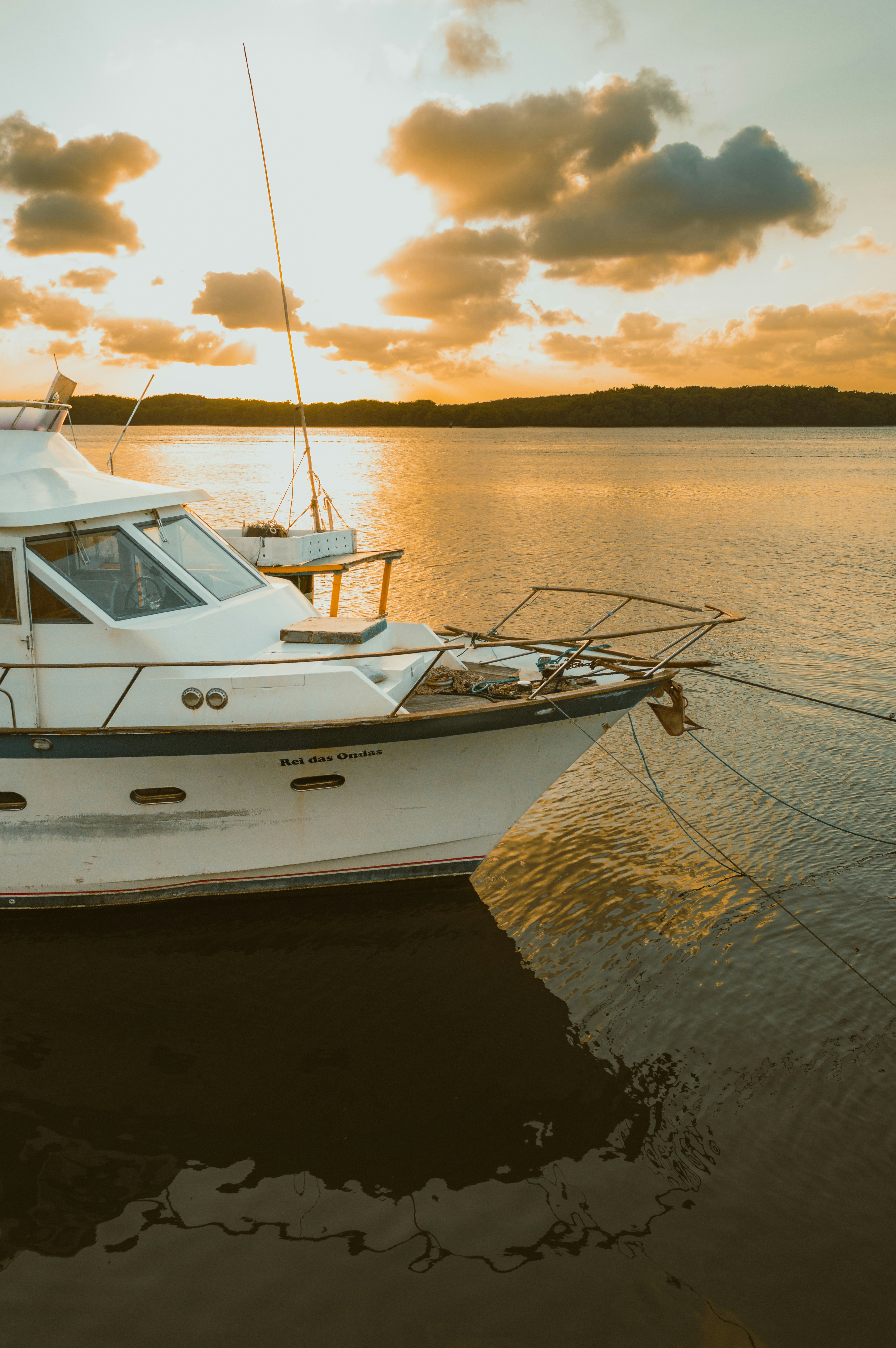 Harbor Lights: A White Yacht Anchored at Dusk