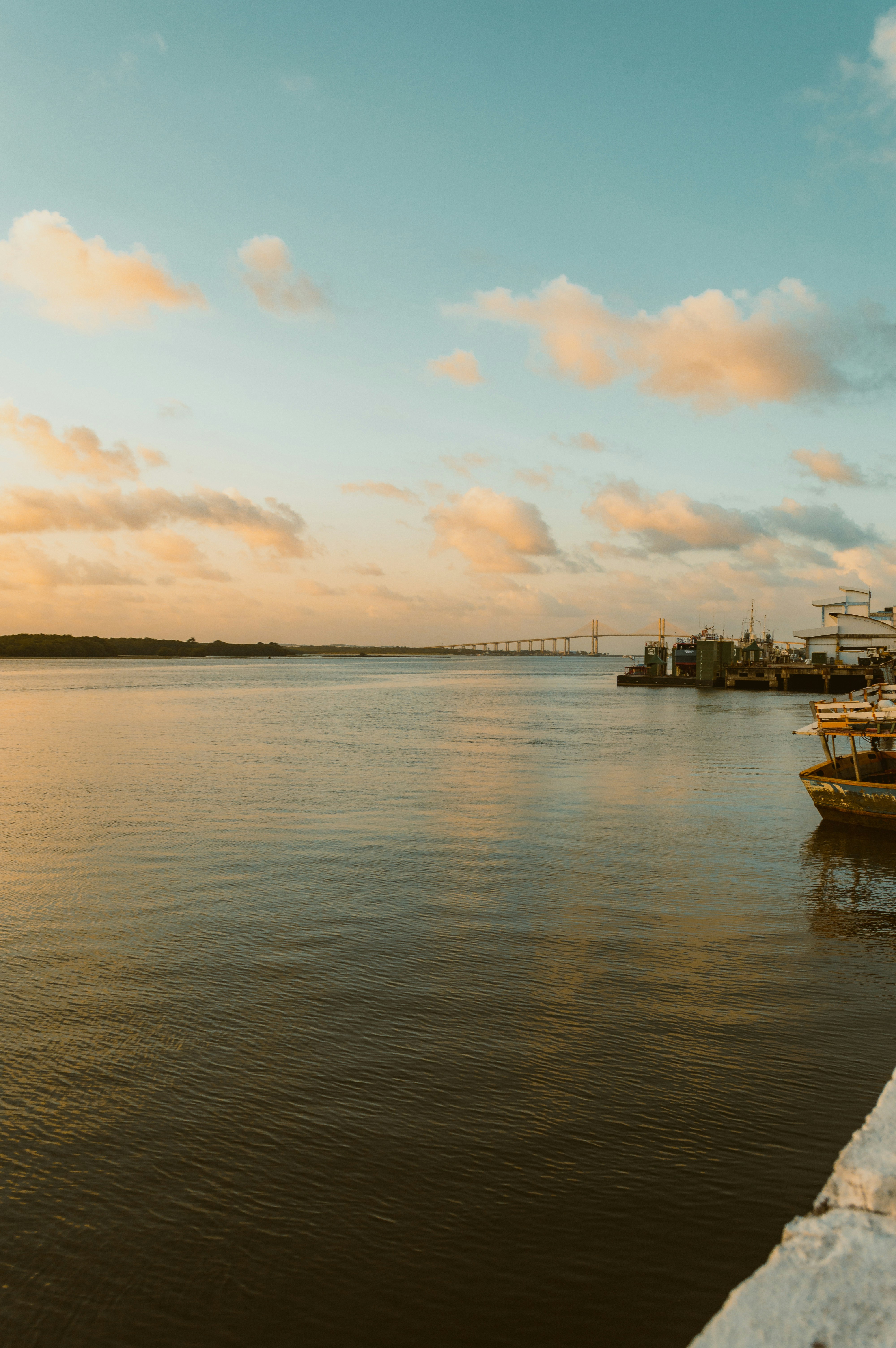 Dusk over the Wharf: Quiet Water and Distant Bridge