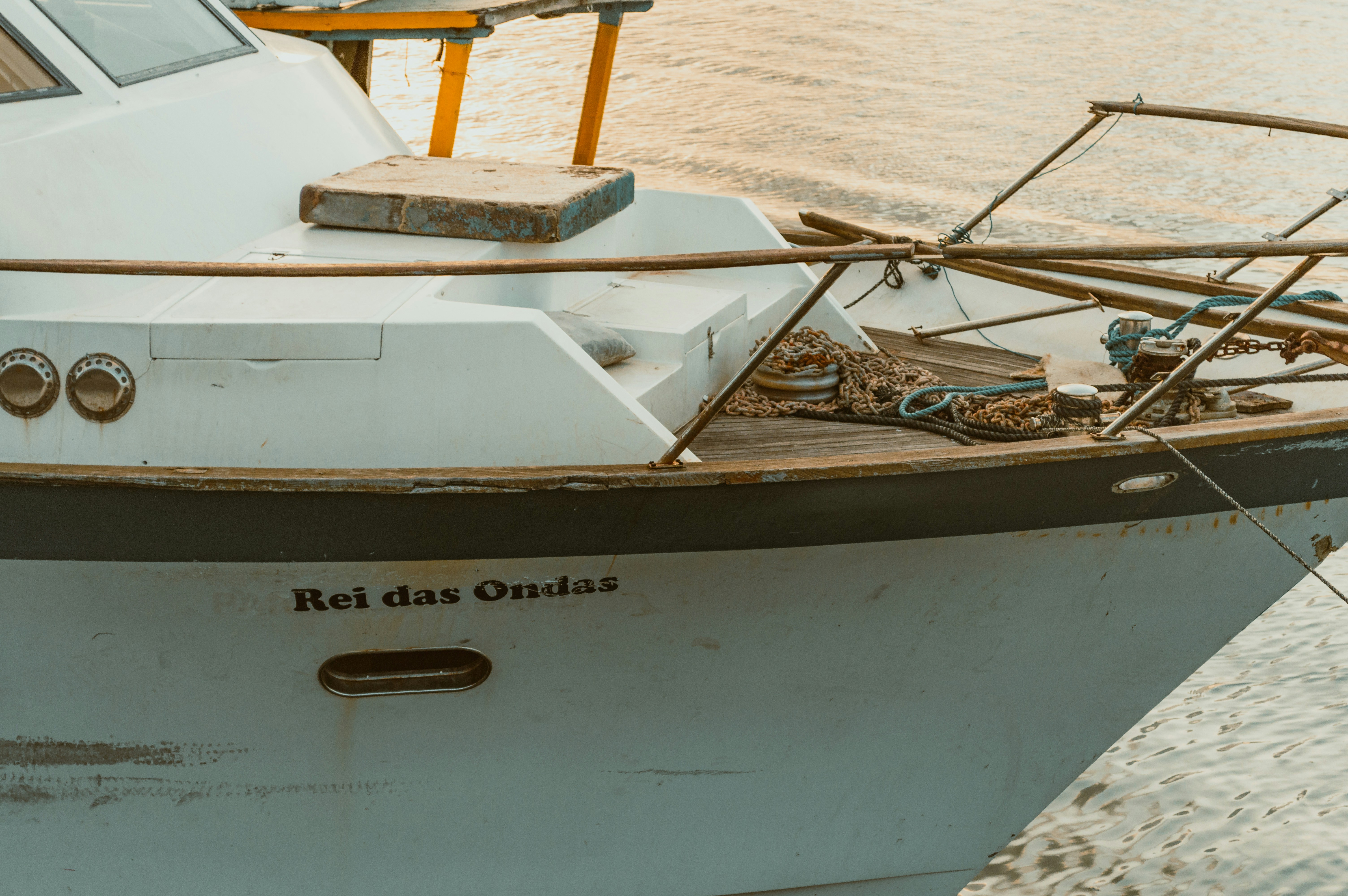 Weathered Bow: The Stubborn Name on a Quiet Seaside Vessel