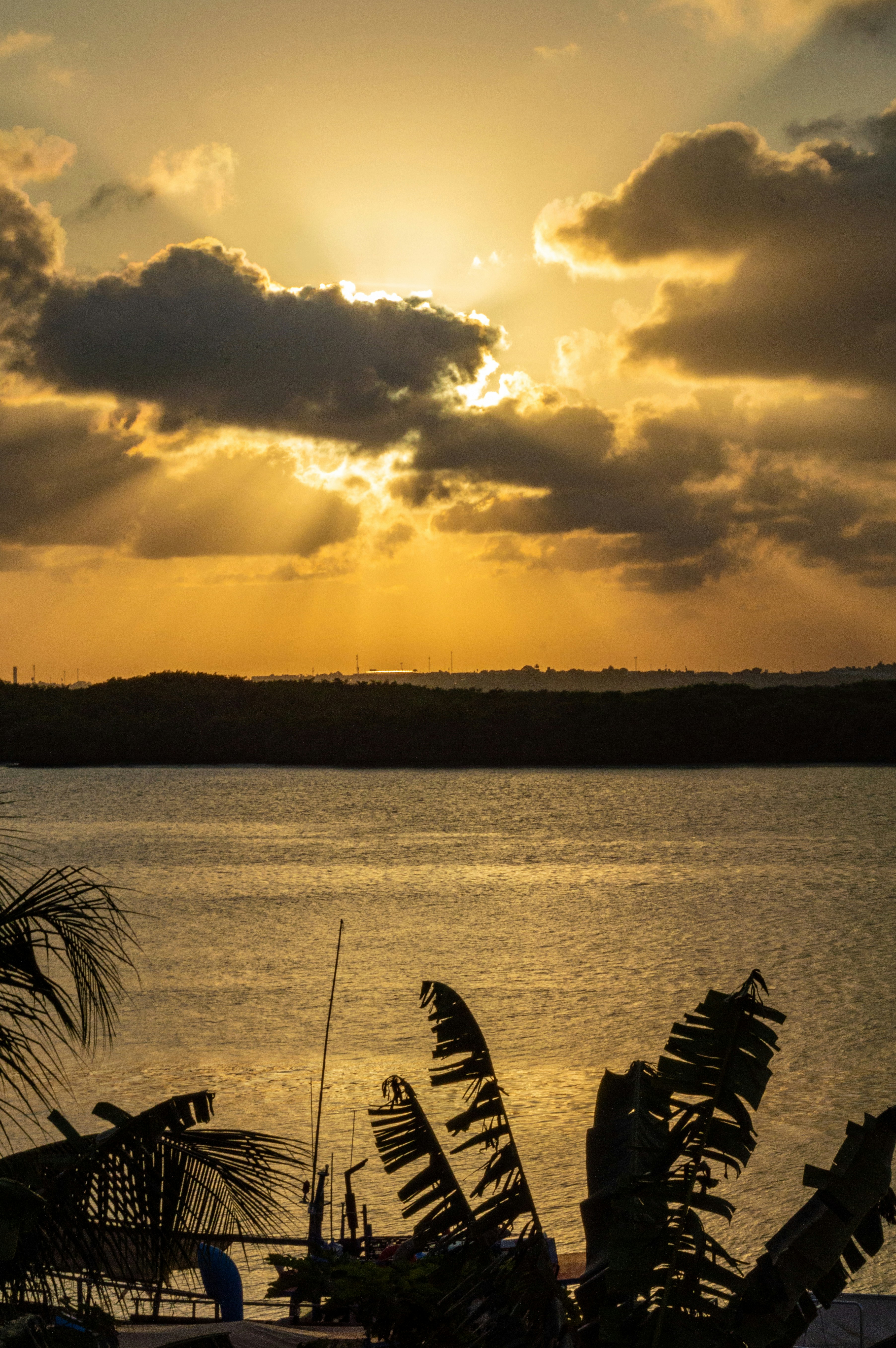Sunbeams through the Golden Horizon over a Quiet Coastal Scene