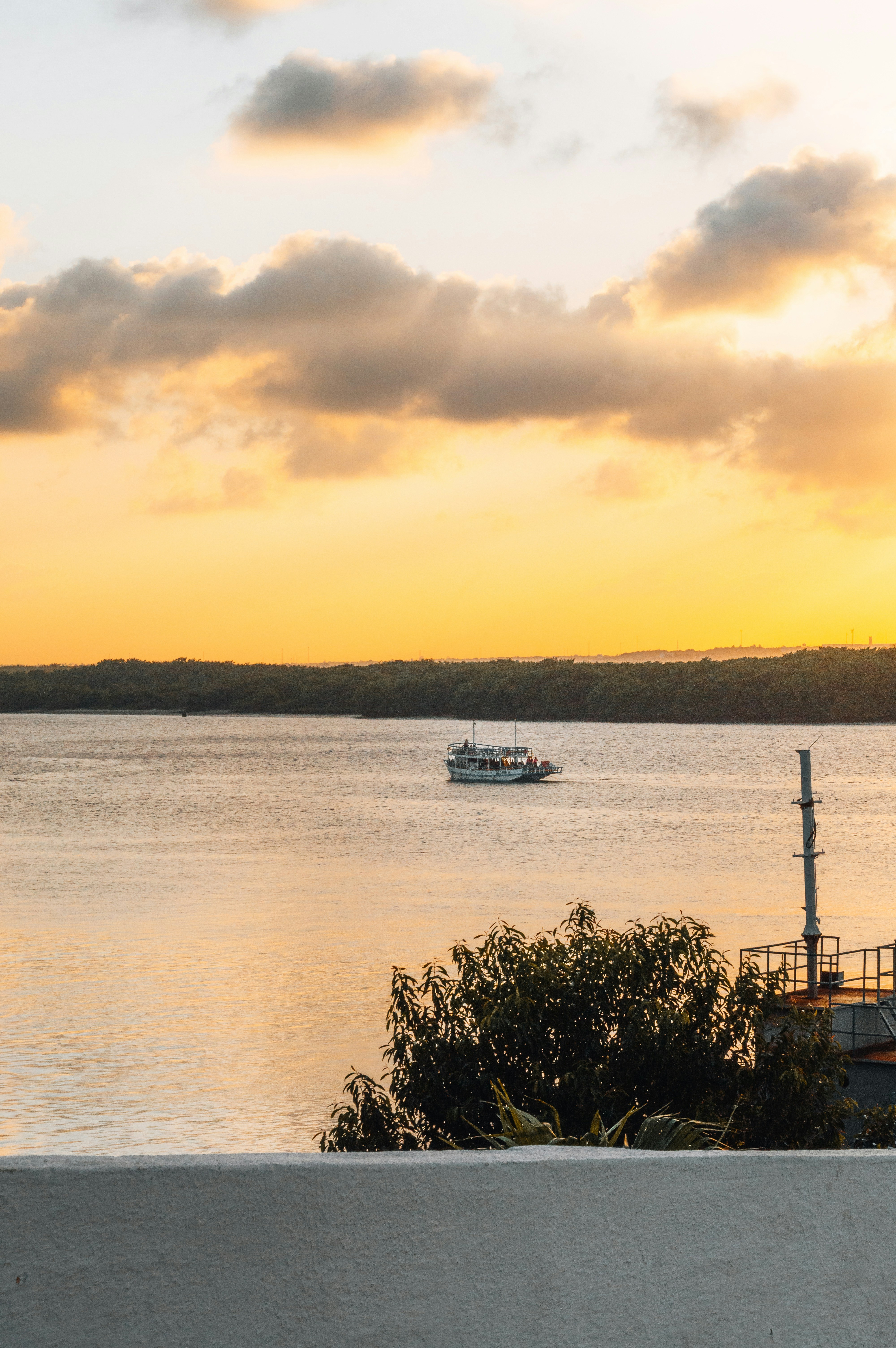 Golden Vessel Drifting on a Quiet Sunset Lake