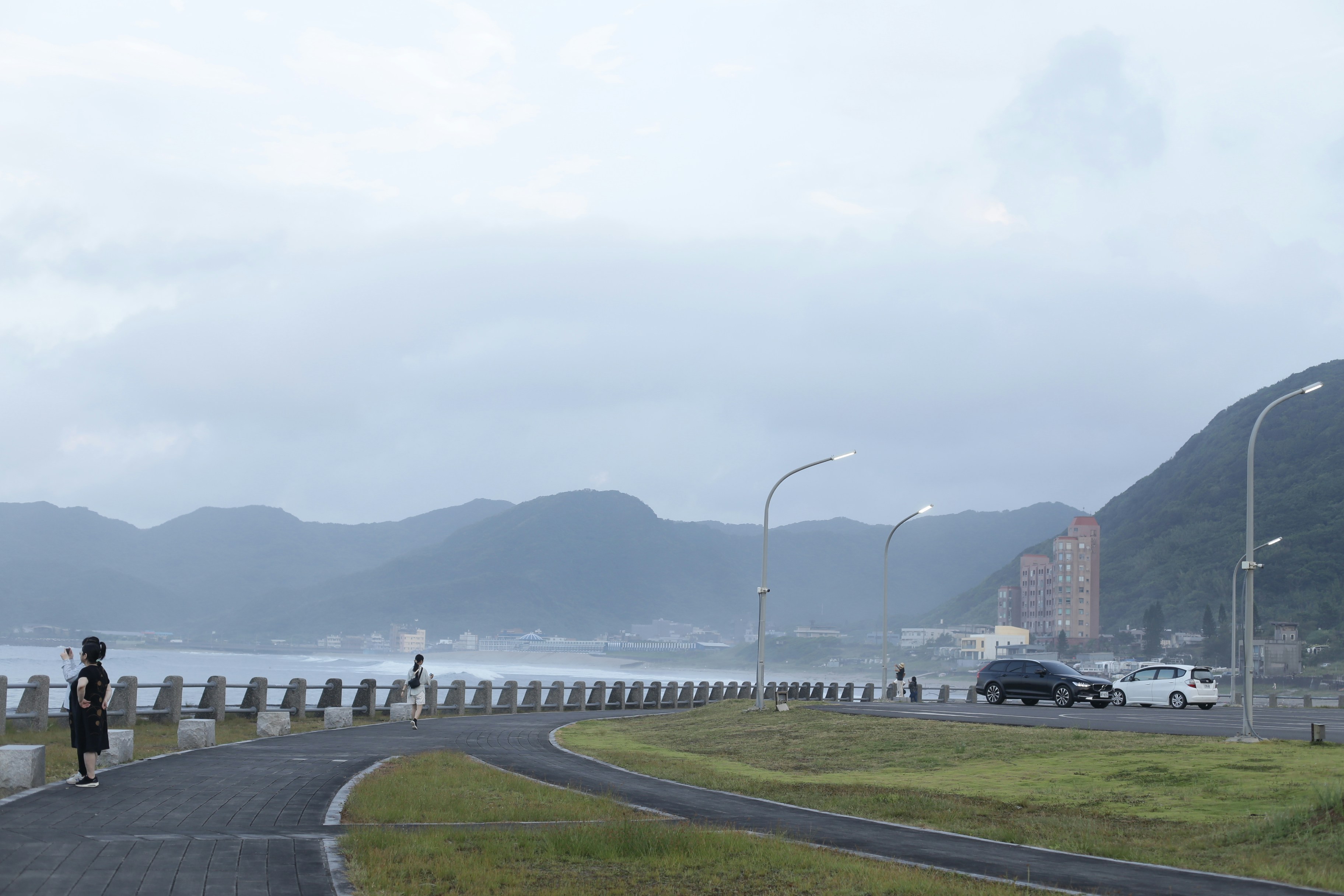 Seaside Promenade under a Cloudy Arc