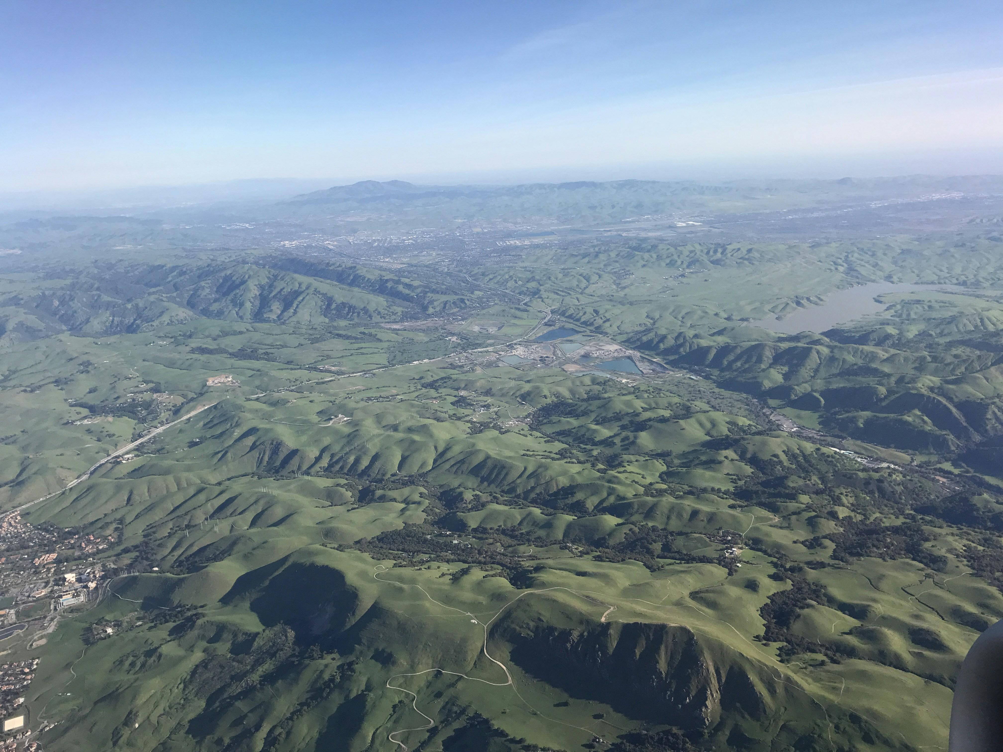 Aerial Veil over Rolling Green Valleys