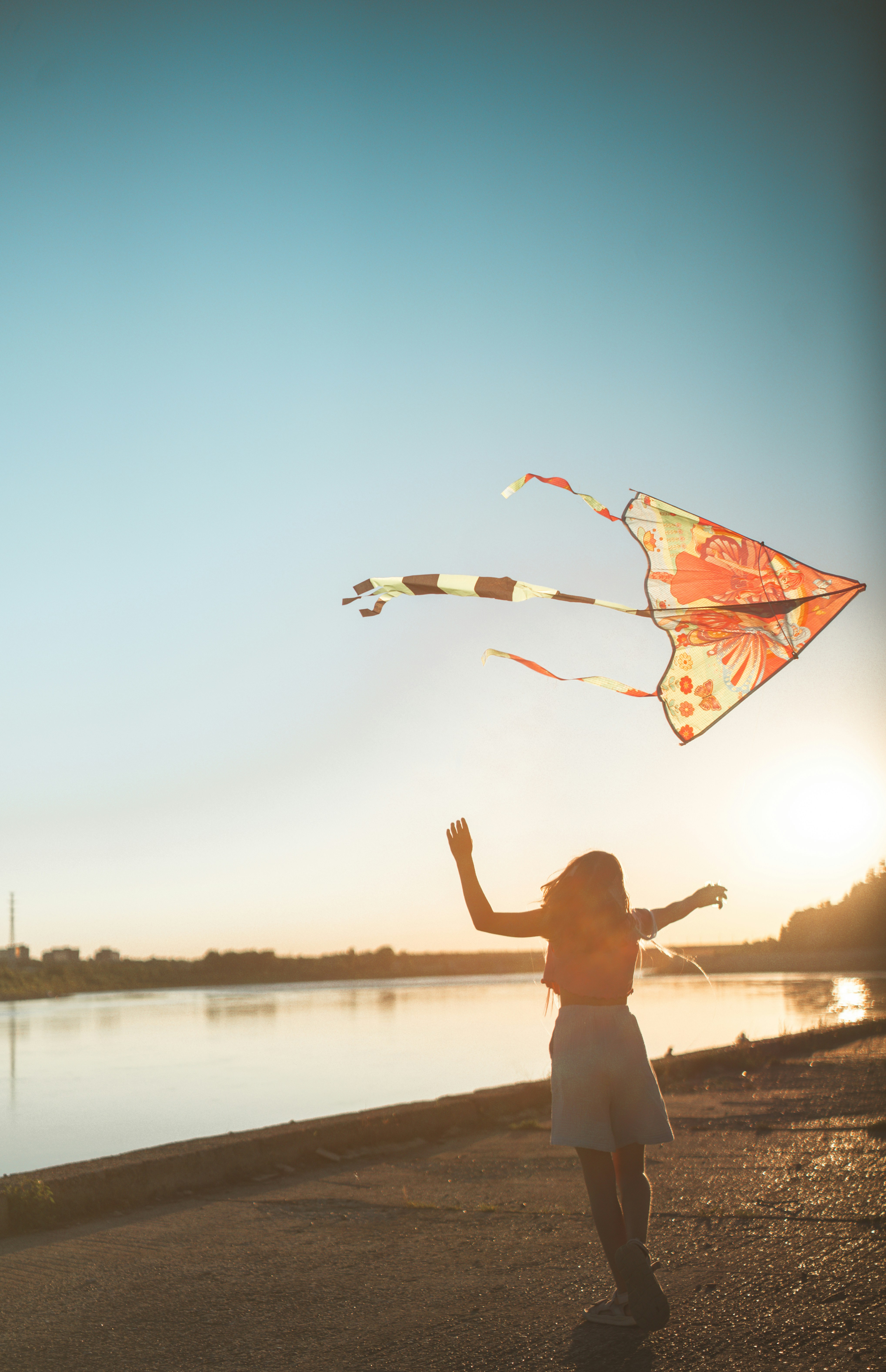 Windswept Joy: A Girl and a Kitesky Horizon