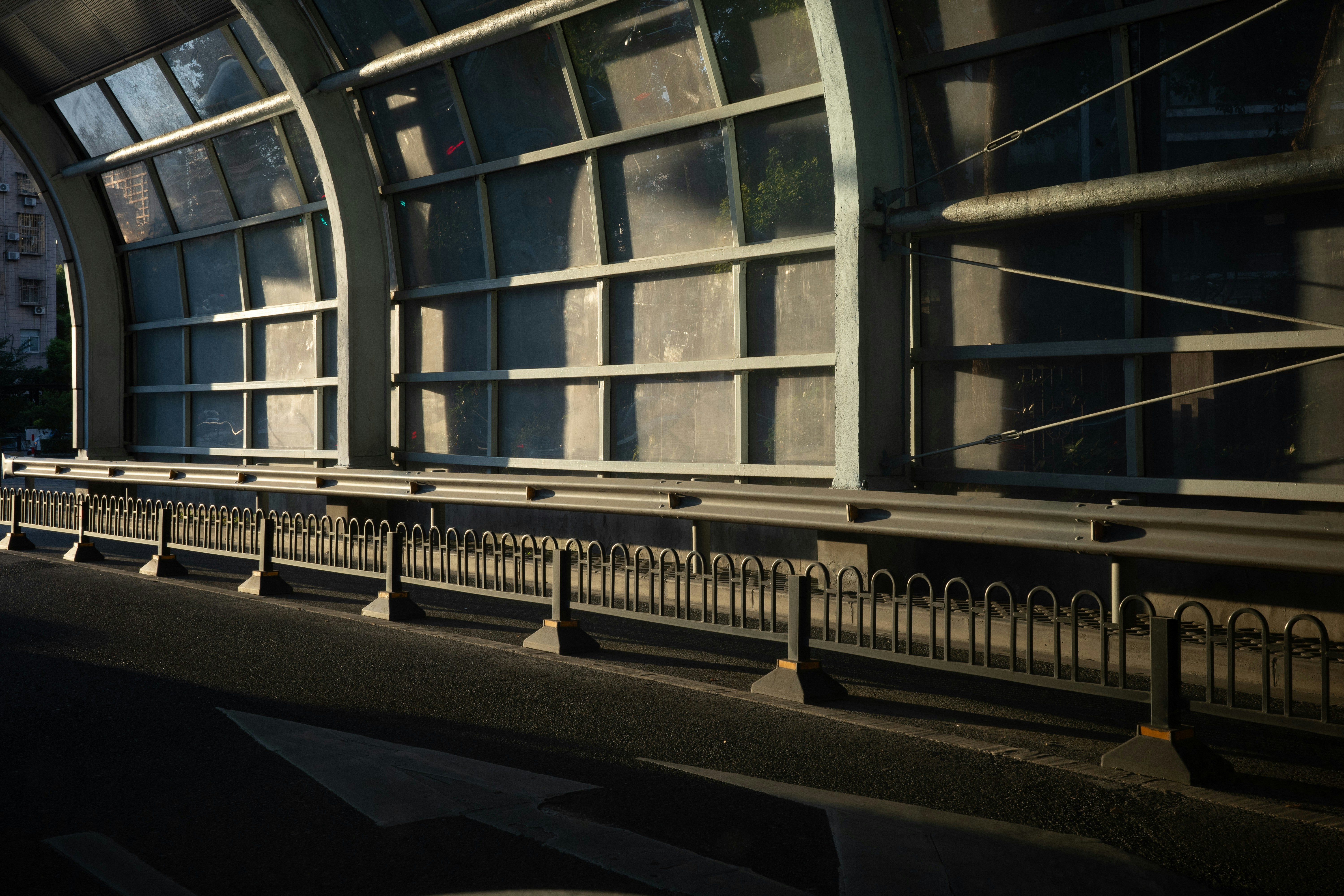 Curved Glass and Railings: Light Skims the Arching Facade