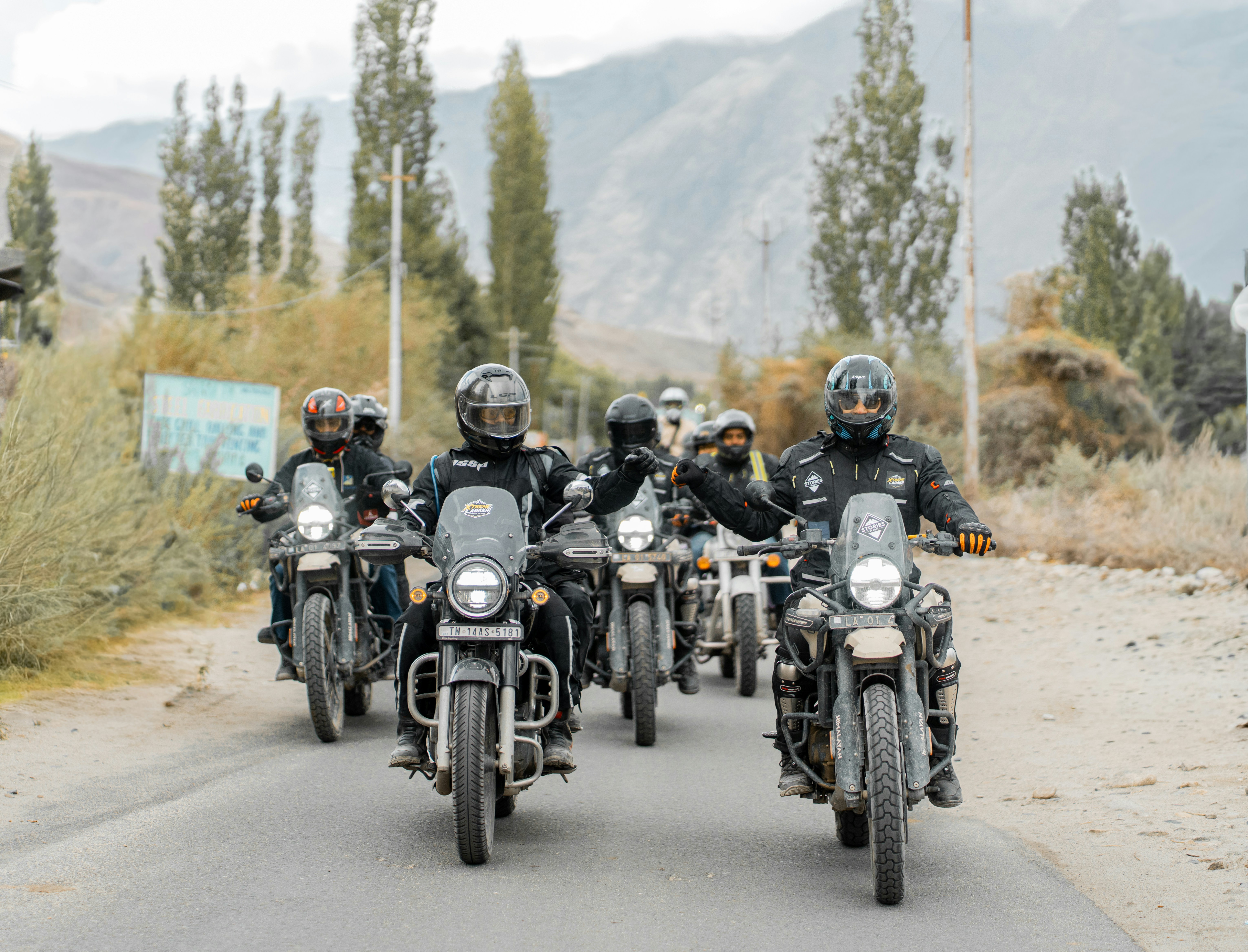 Frontline Ride: A Pack of Riders Edge Forward on a Desert Road