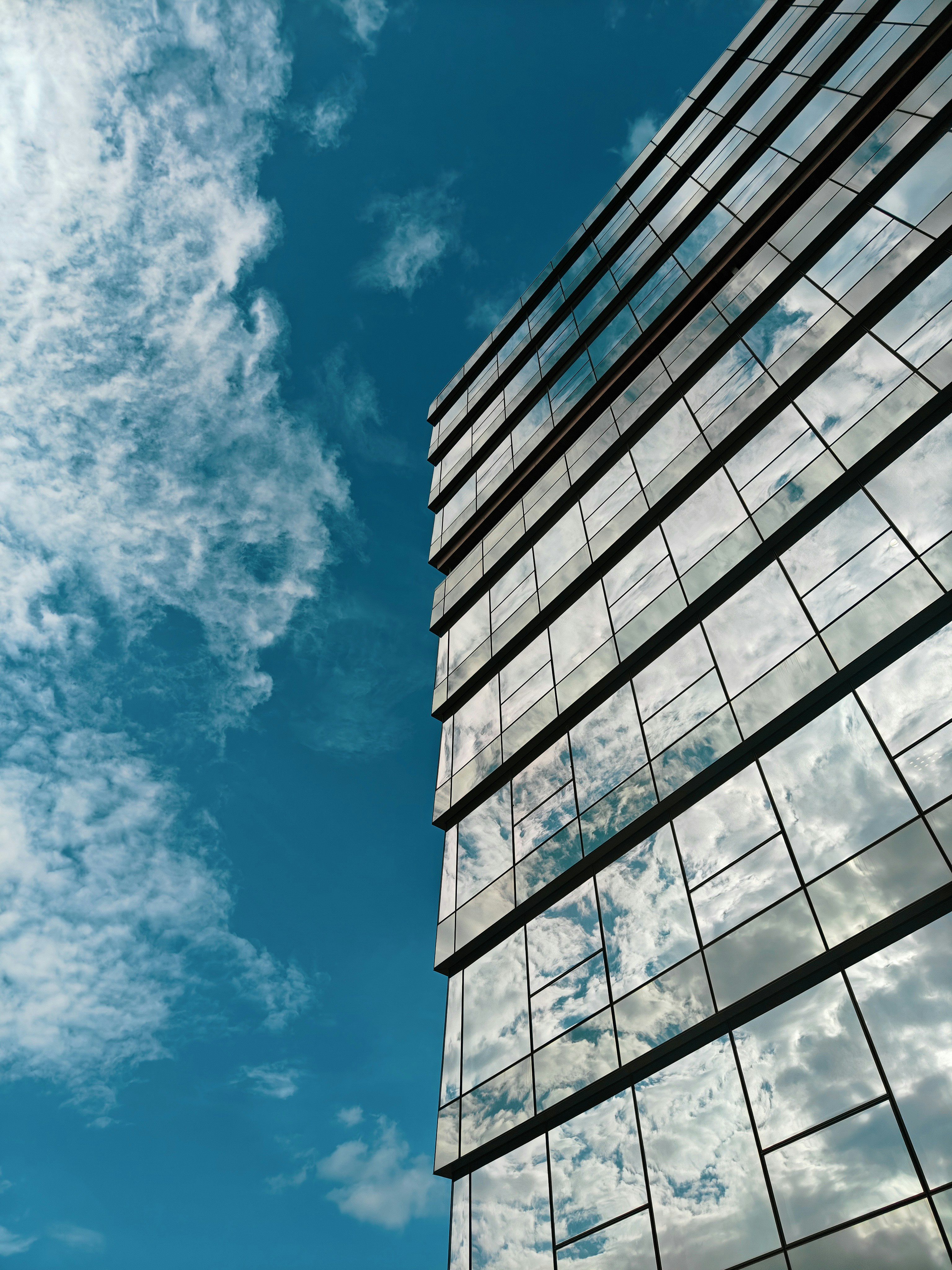 Glass Facade Skies: A Tower Reaching into the Blue