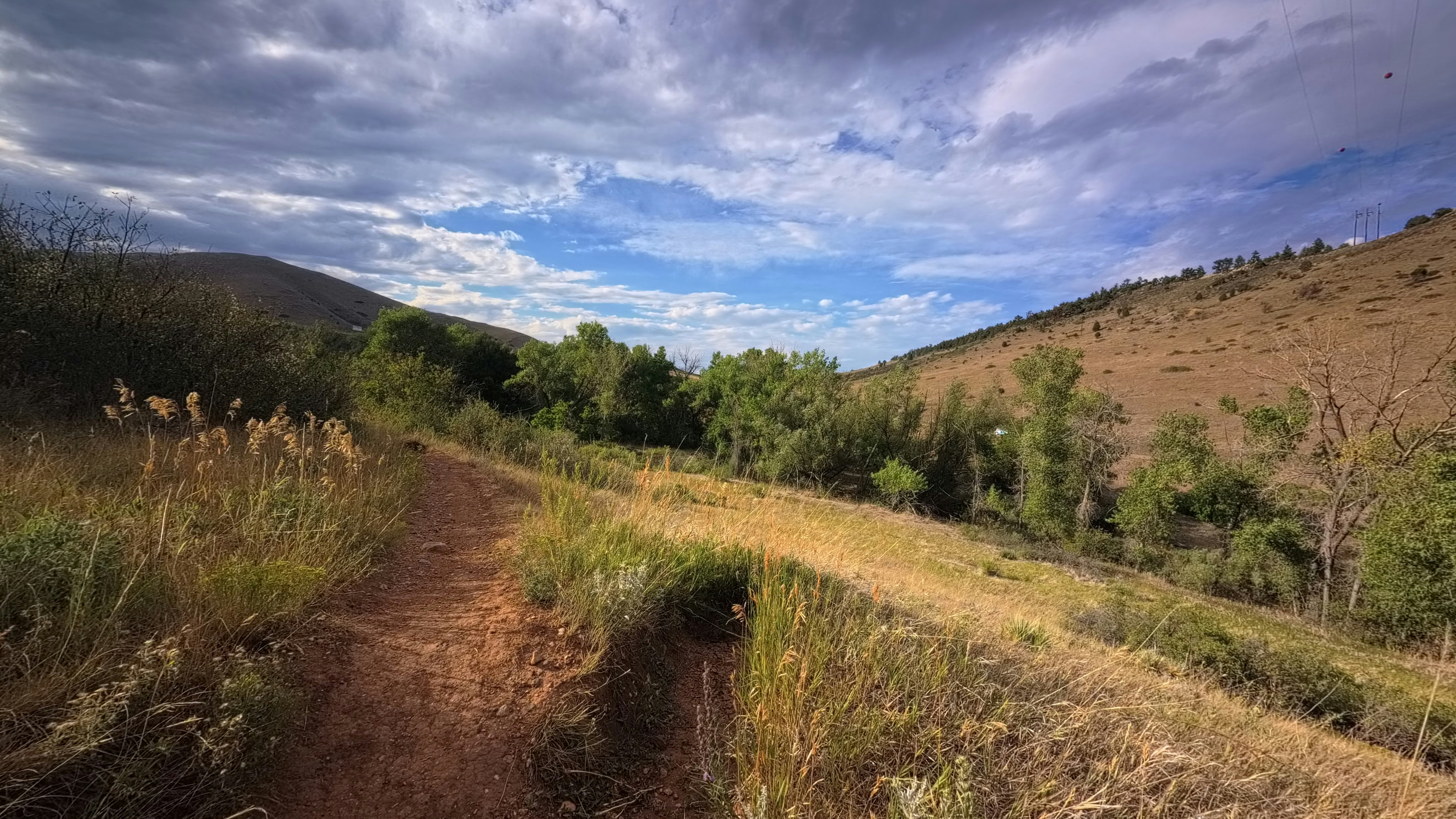 Trail Between Hills: Quiet Path Under a Wide Sky