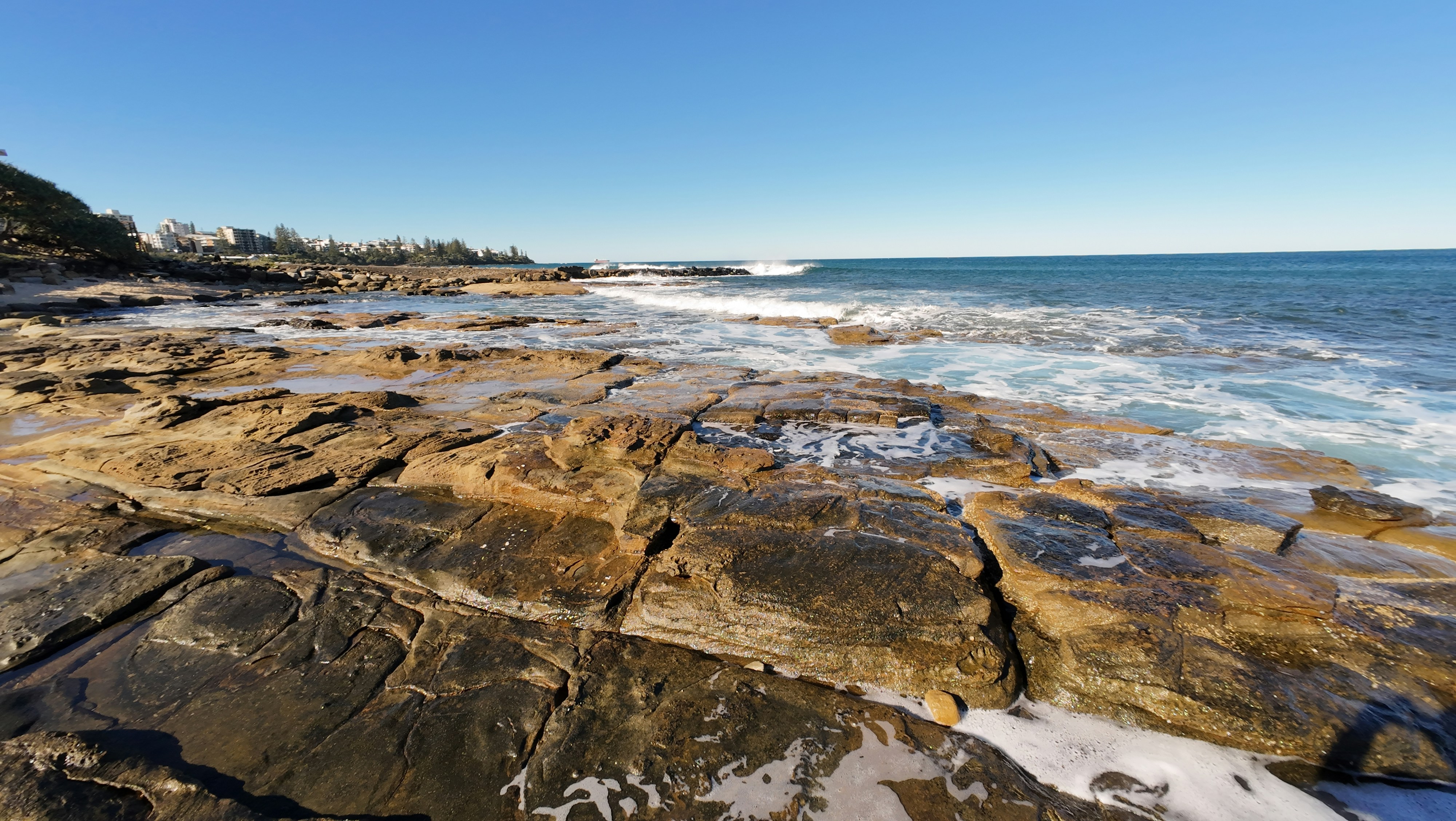Coastal Rockscape Under a Clear Surfing Sky