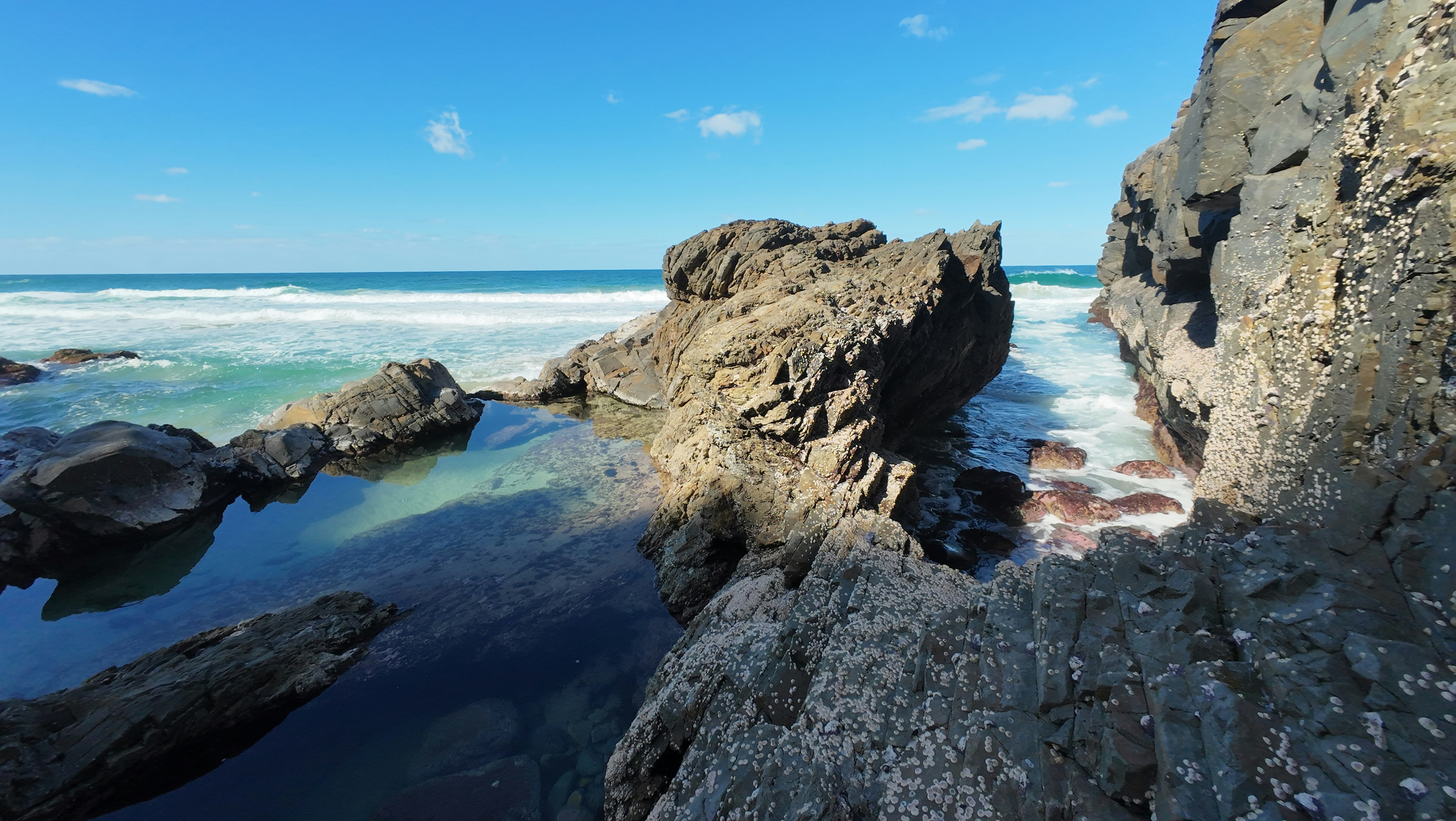 Rugged shoreline carved by tides under a cobalt sky