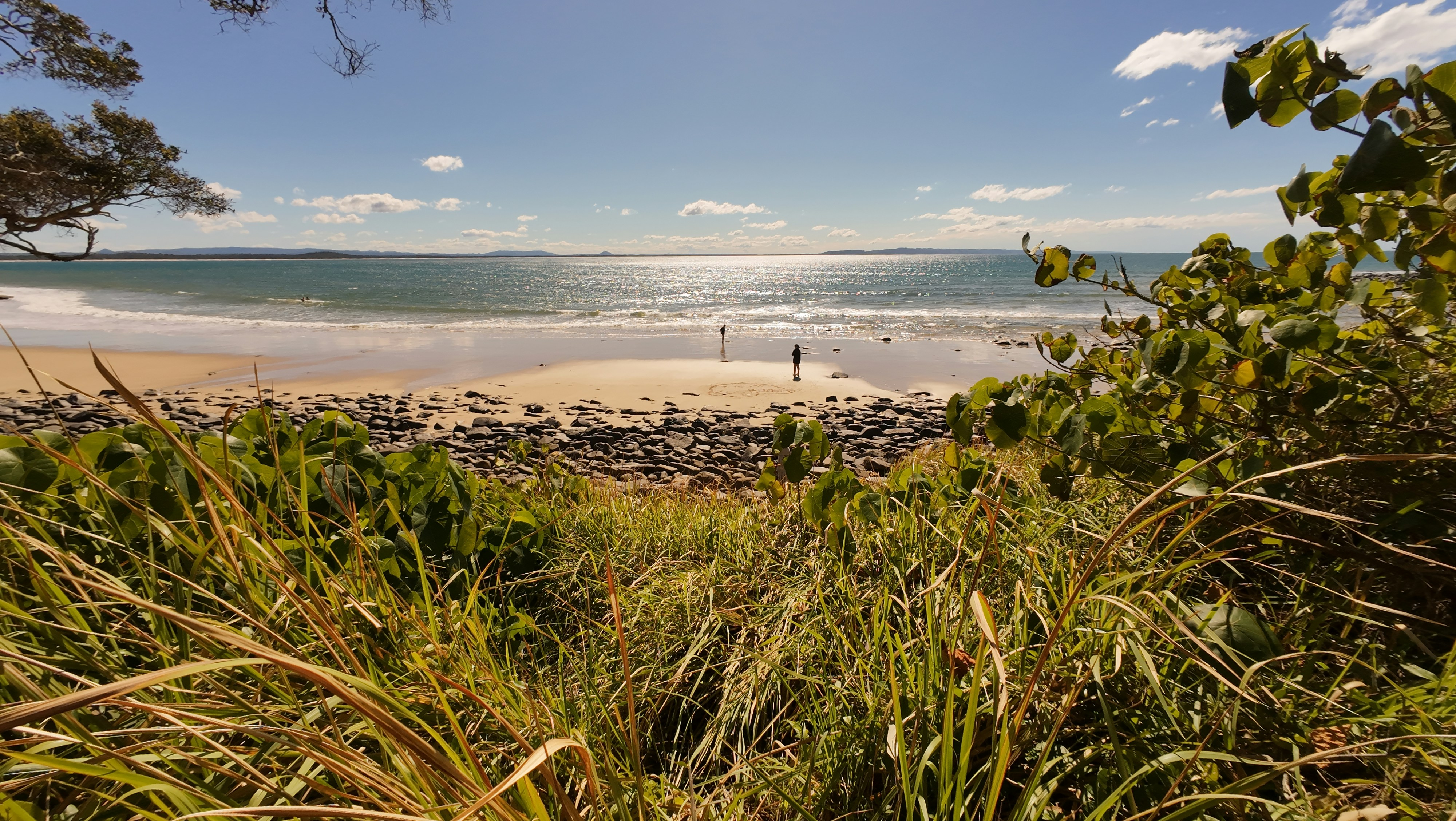 Coastal Dunes framing a lone beachgoer at the horizon
