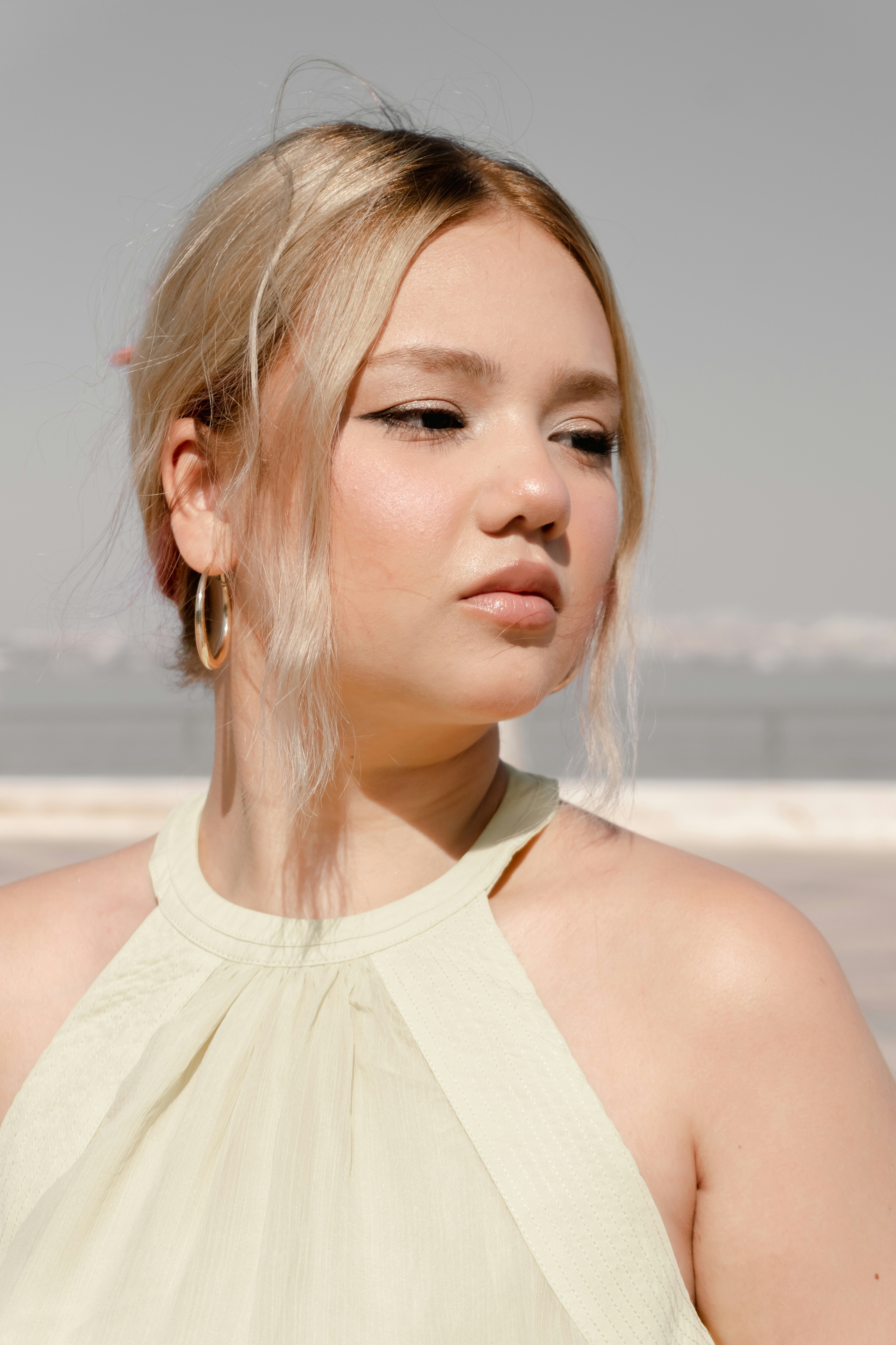 Sunlit Contemplation: A Soft Portrait on the Wind-Kissed Beach