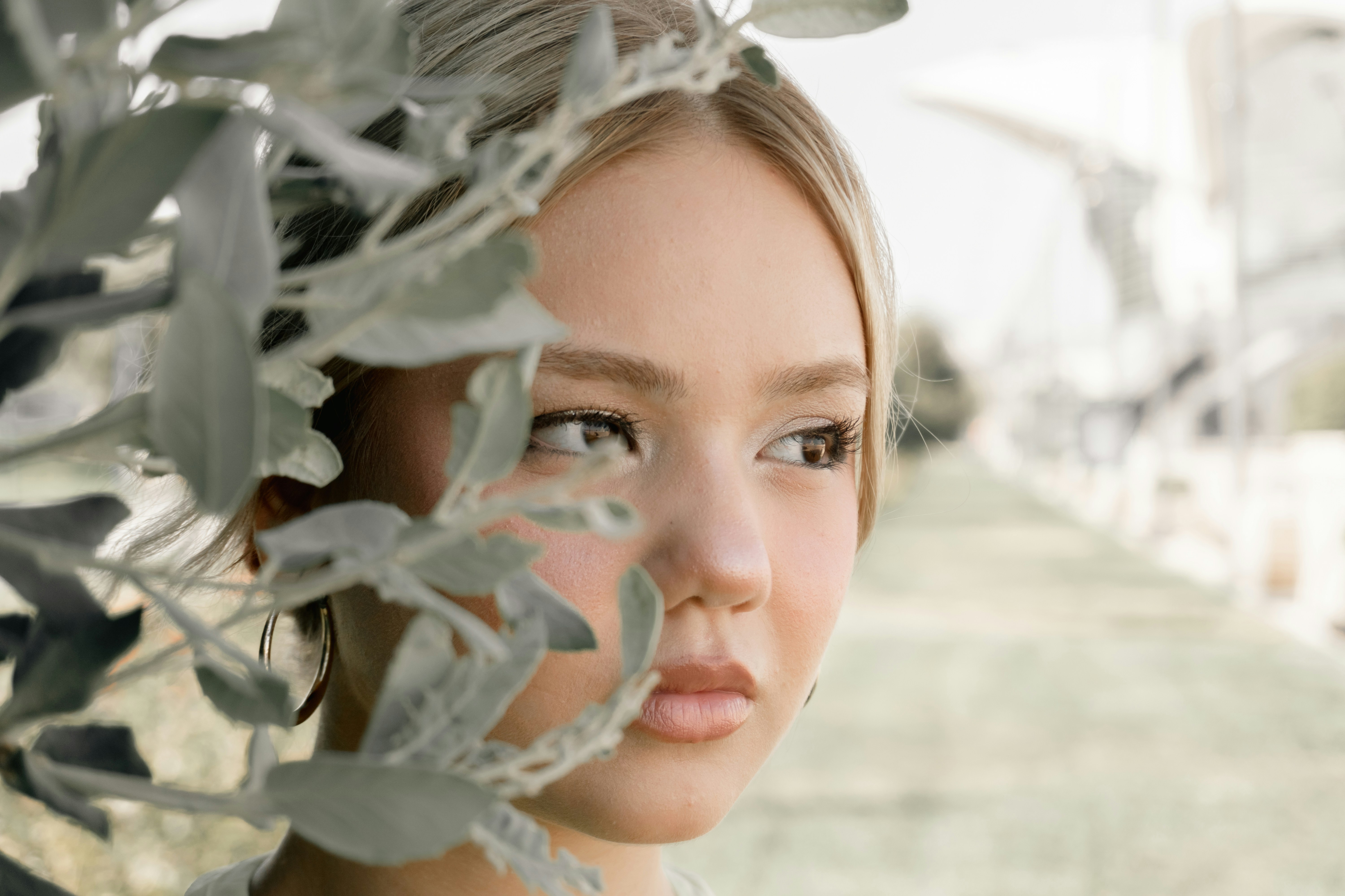 Soft Focus Portrait Amid Botanical Veil