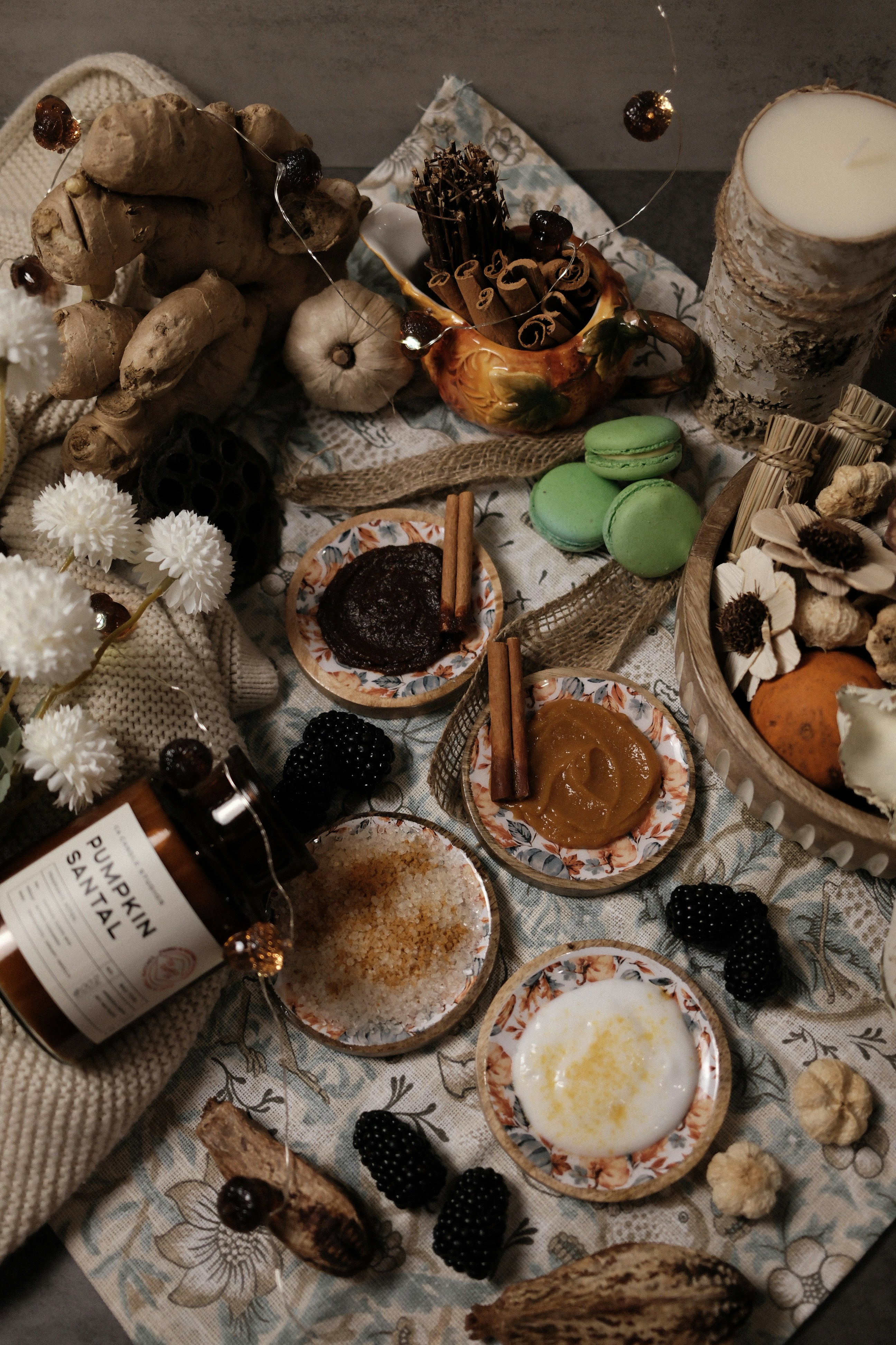 Autumnal Still Life: Spiced Dishes and Cocoa Macarons on a Rustic Table