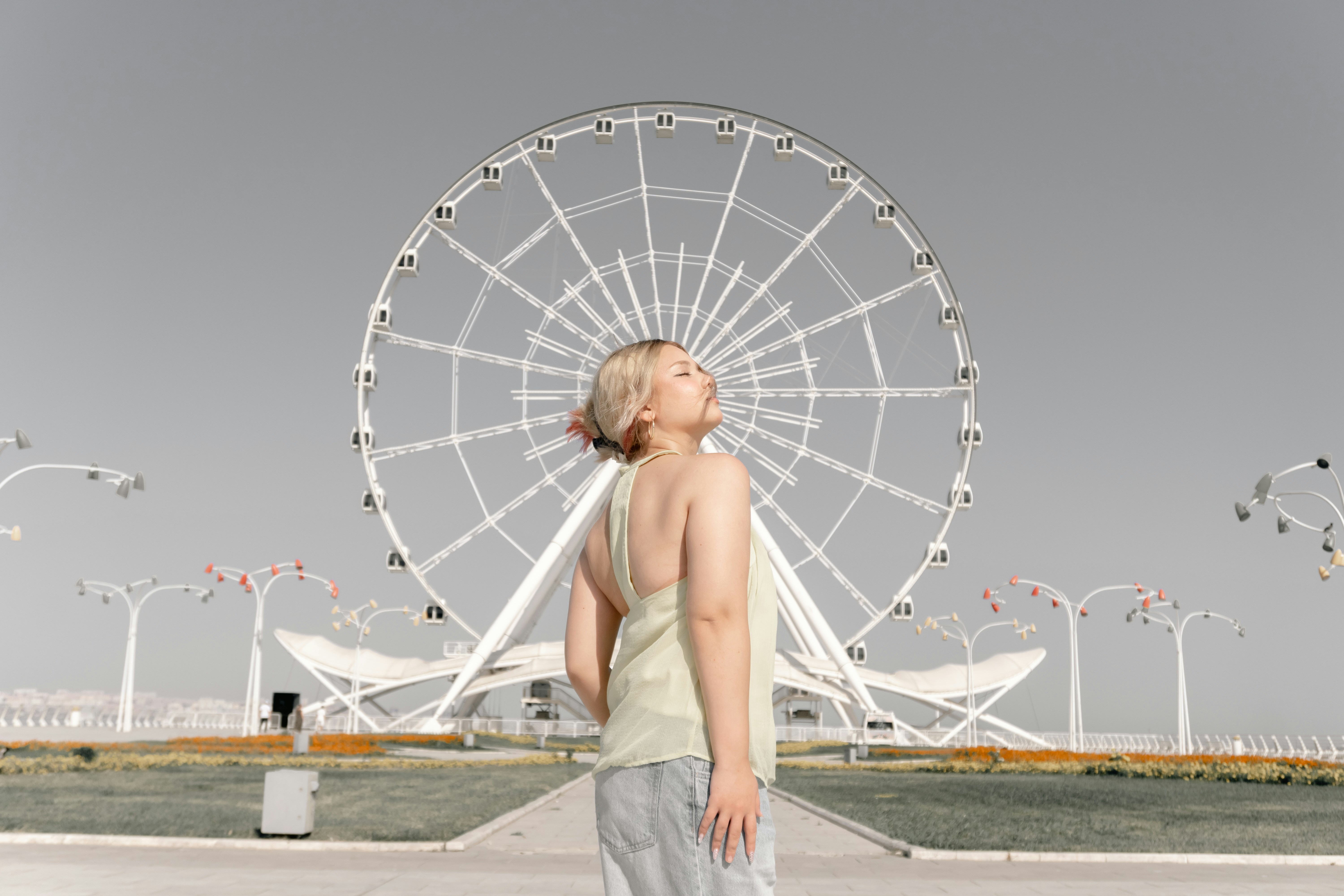 Sunlit Portrait Beneath a Giant Wheel