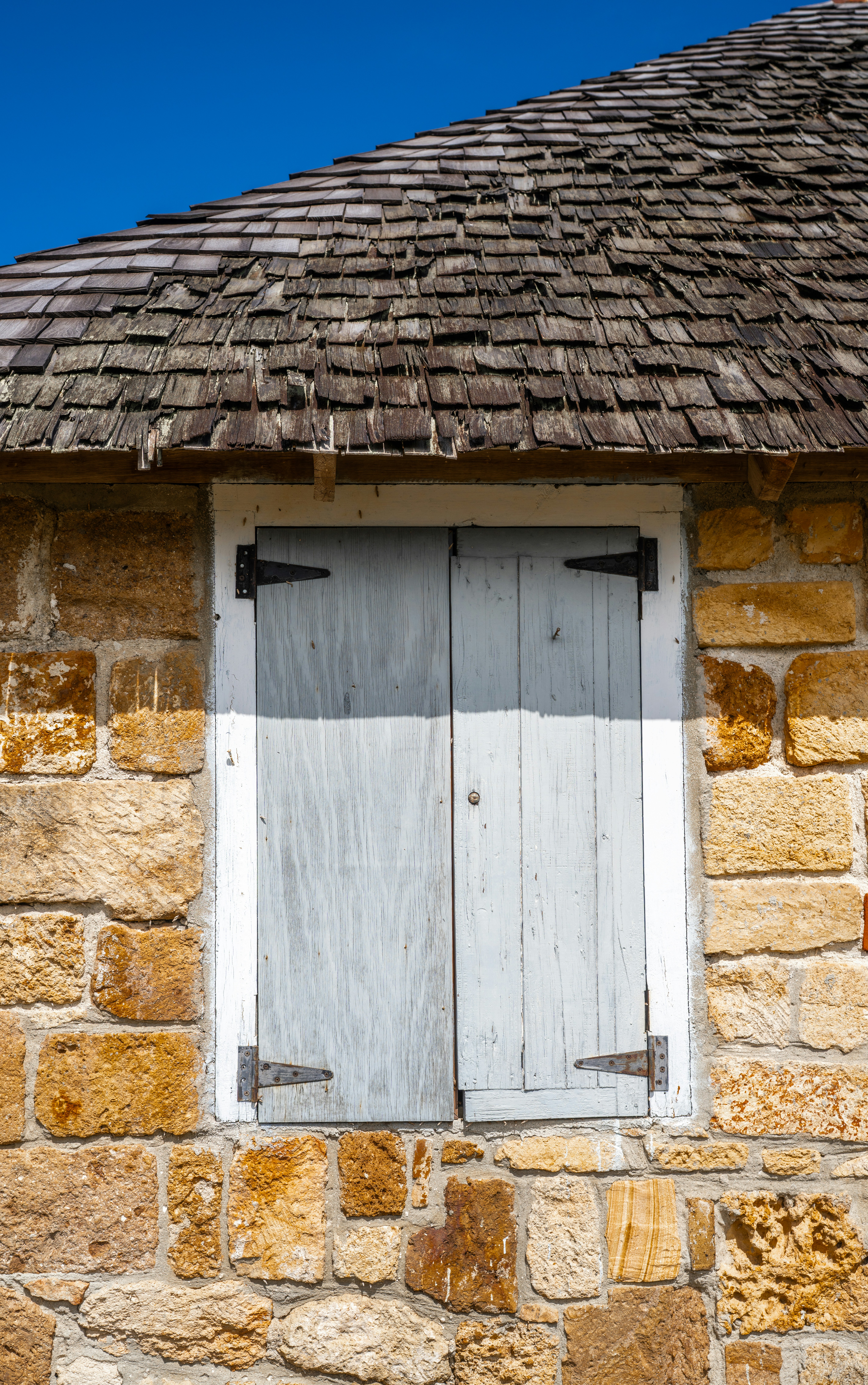 Weathered Blue Door under a Shingled Roof