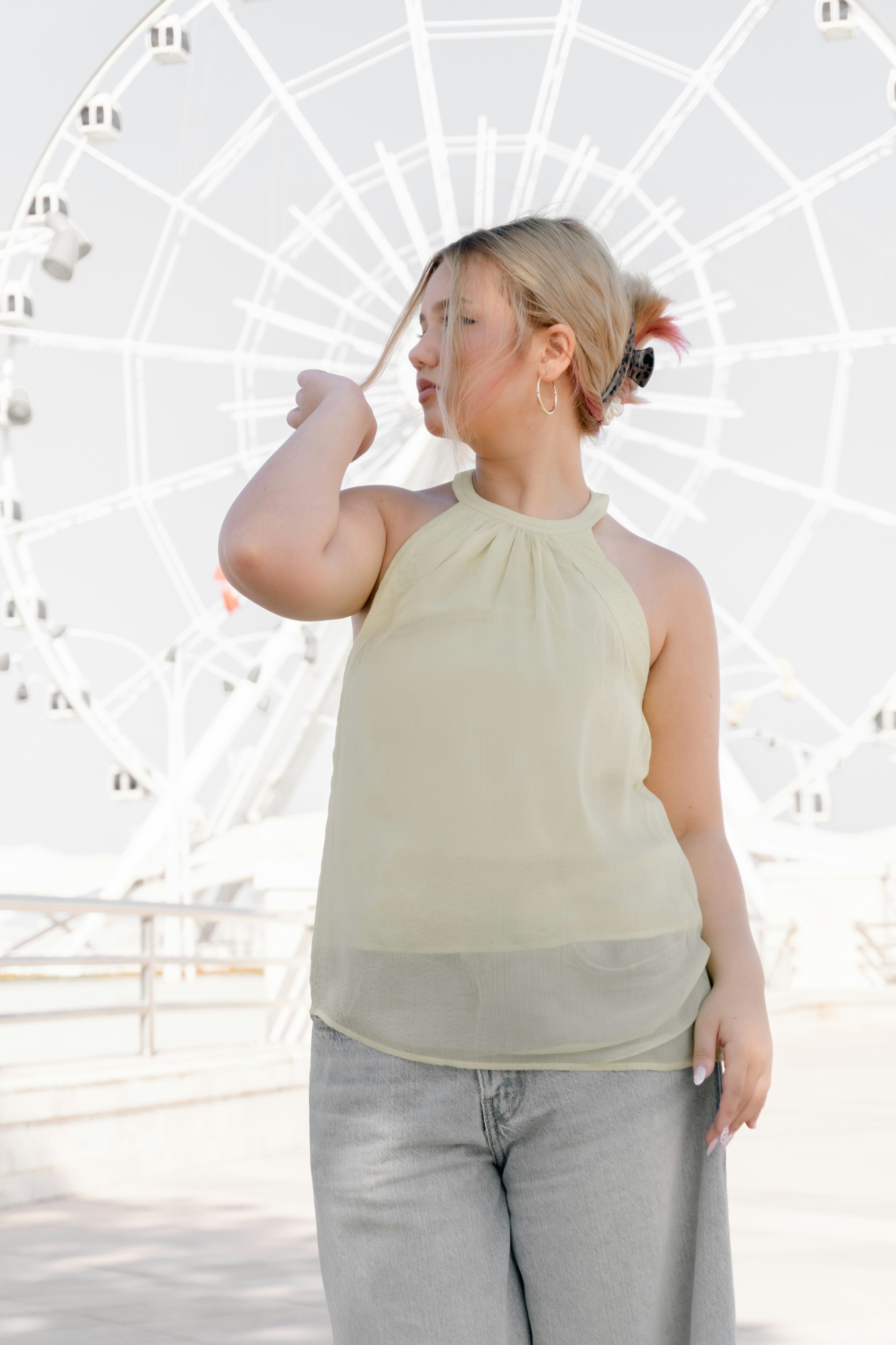 Boardwalk Moment: Portrait Amidst a Sunlit Ferris Wheel