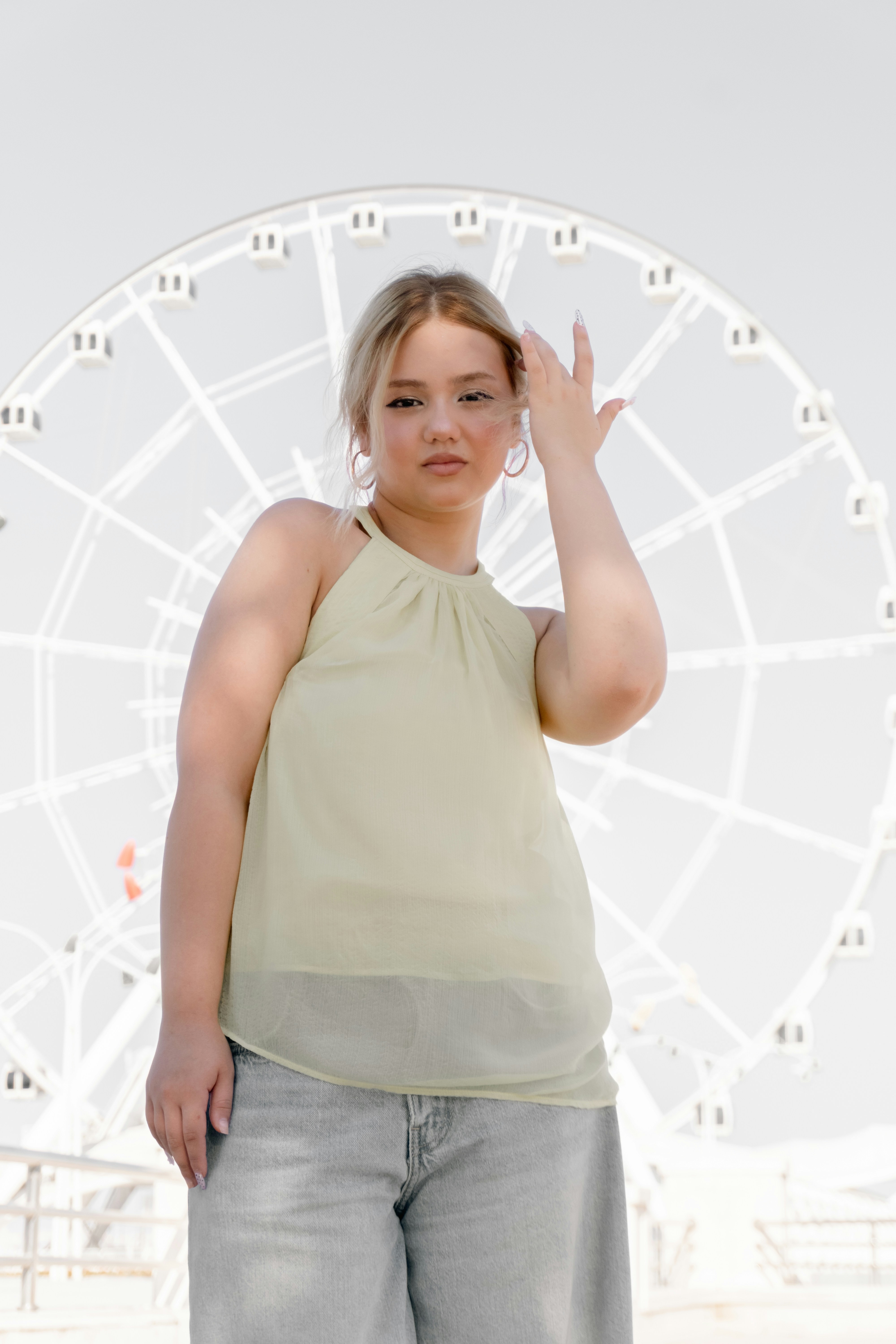 Centered Confidence: A Bright Portrait Against the Ferris Wheel