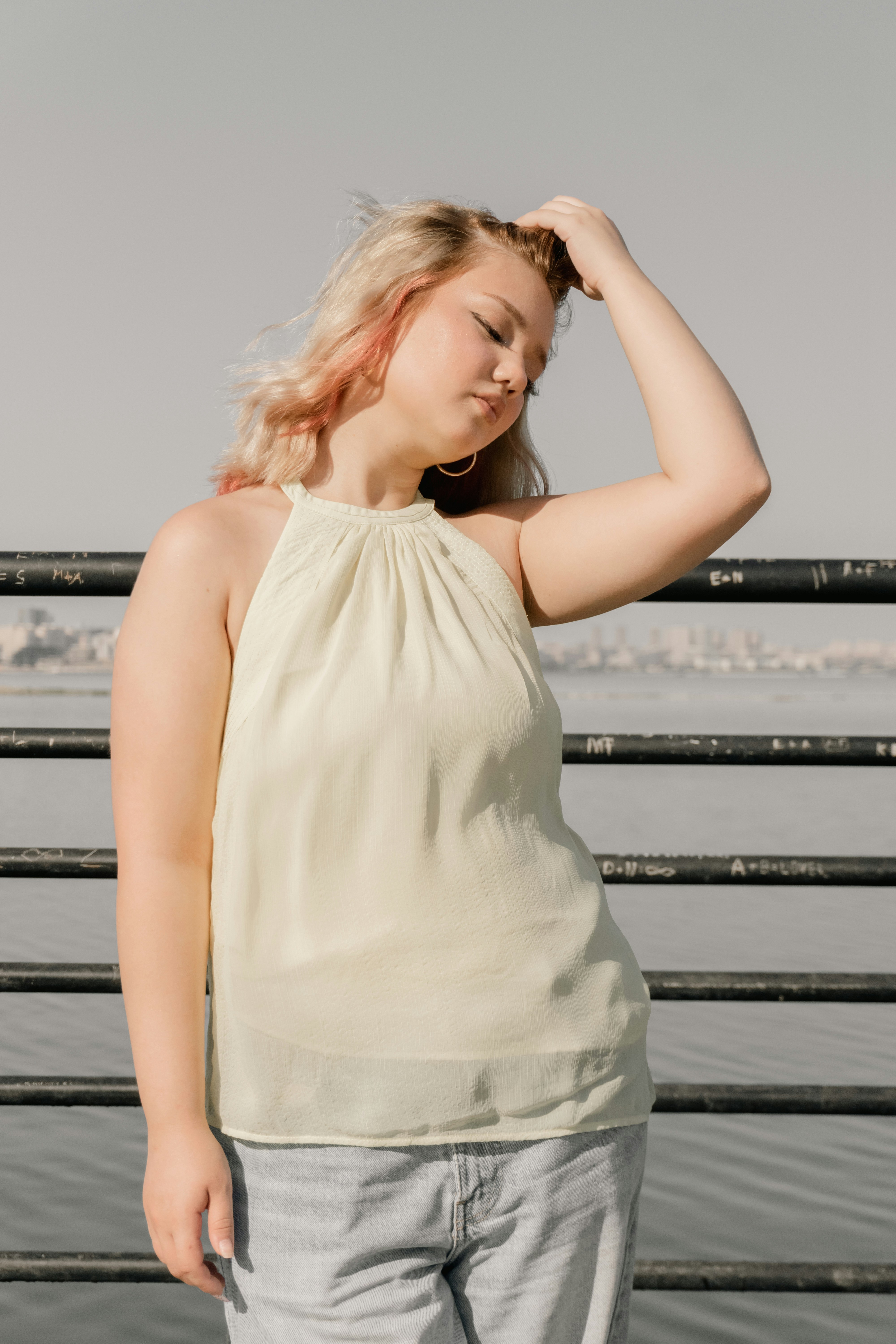 Sunlit Portrait by the Waterfront Railings