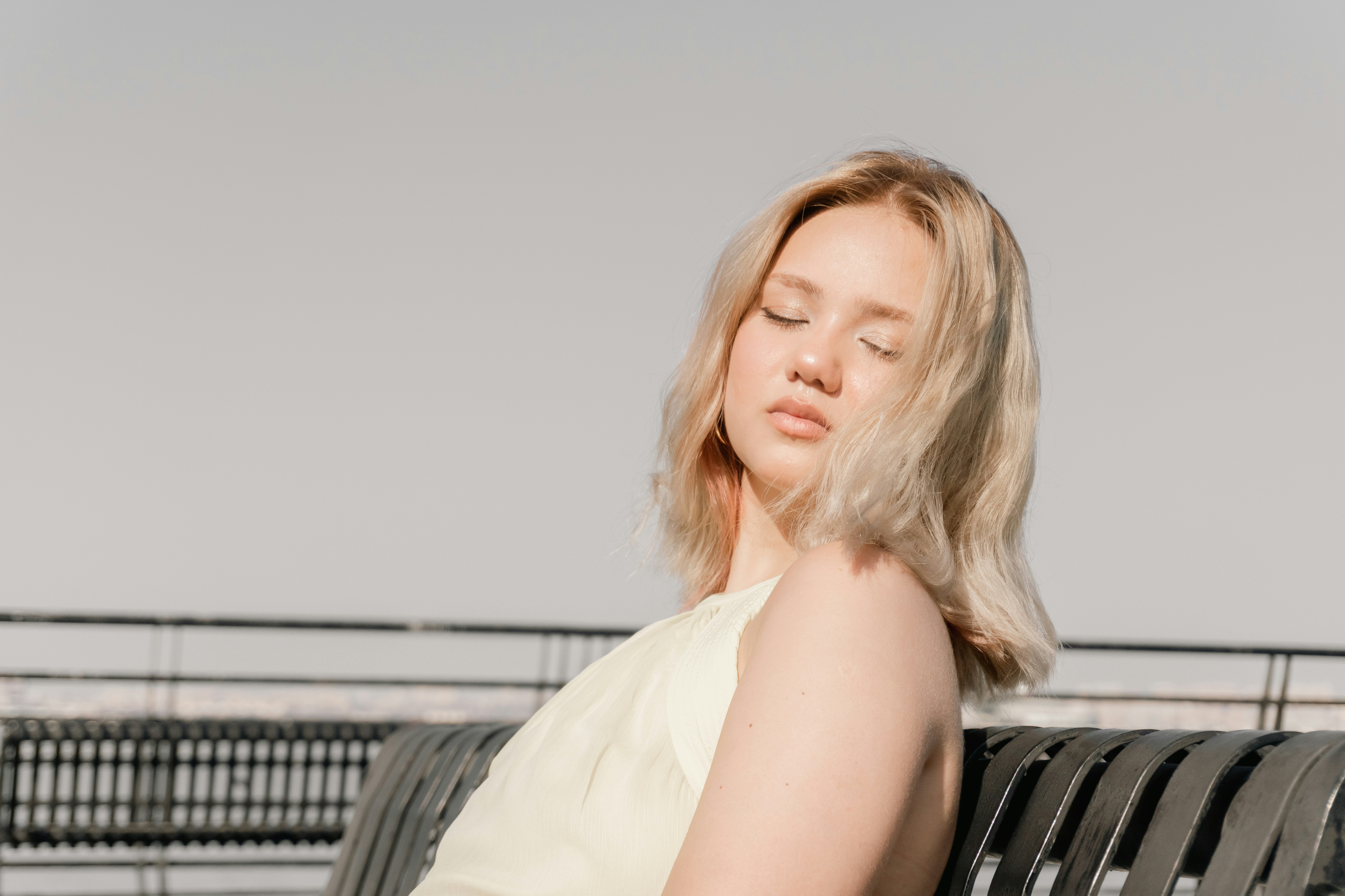 Sunlit Silence: A Crescent of Hair and Soft Gaze