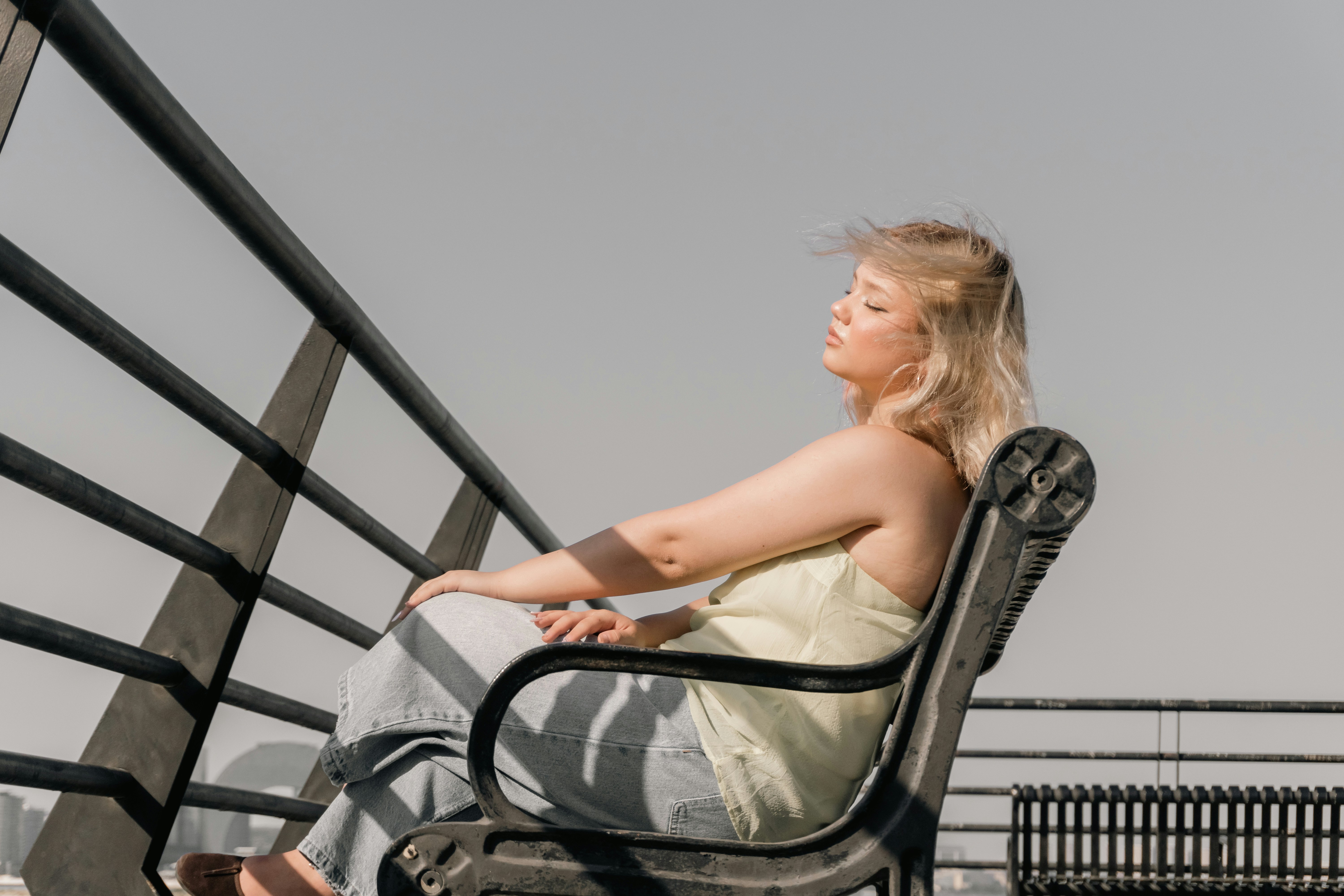 Sunlit Recline: A Quiet Moment on the Riverside Bench