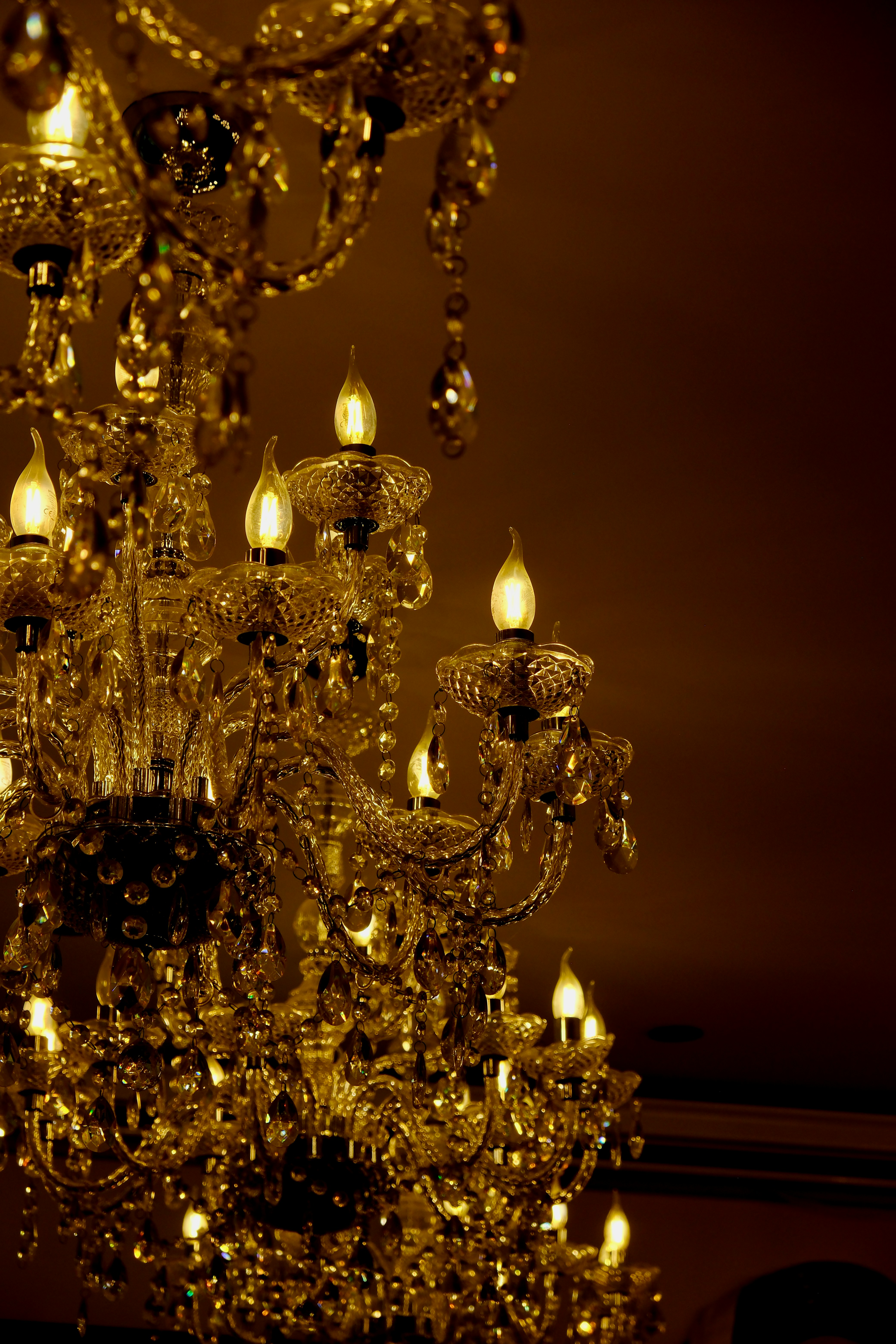 Golden Cascade: A Crystal Chandelier Bathed in Candlelight