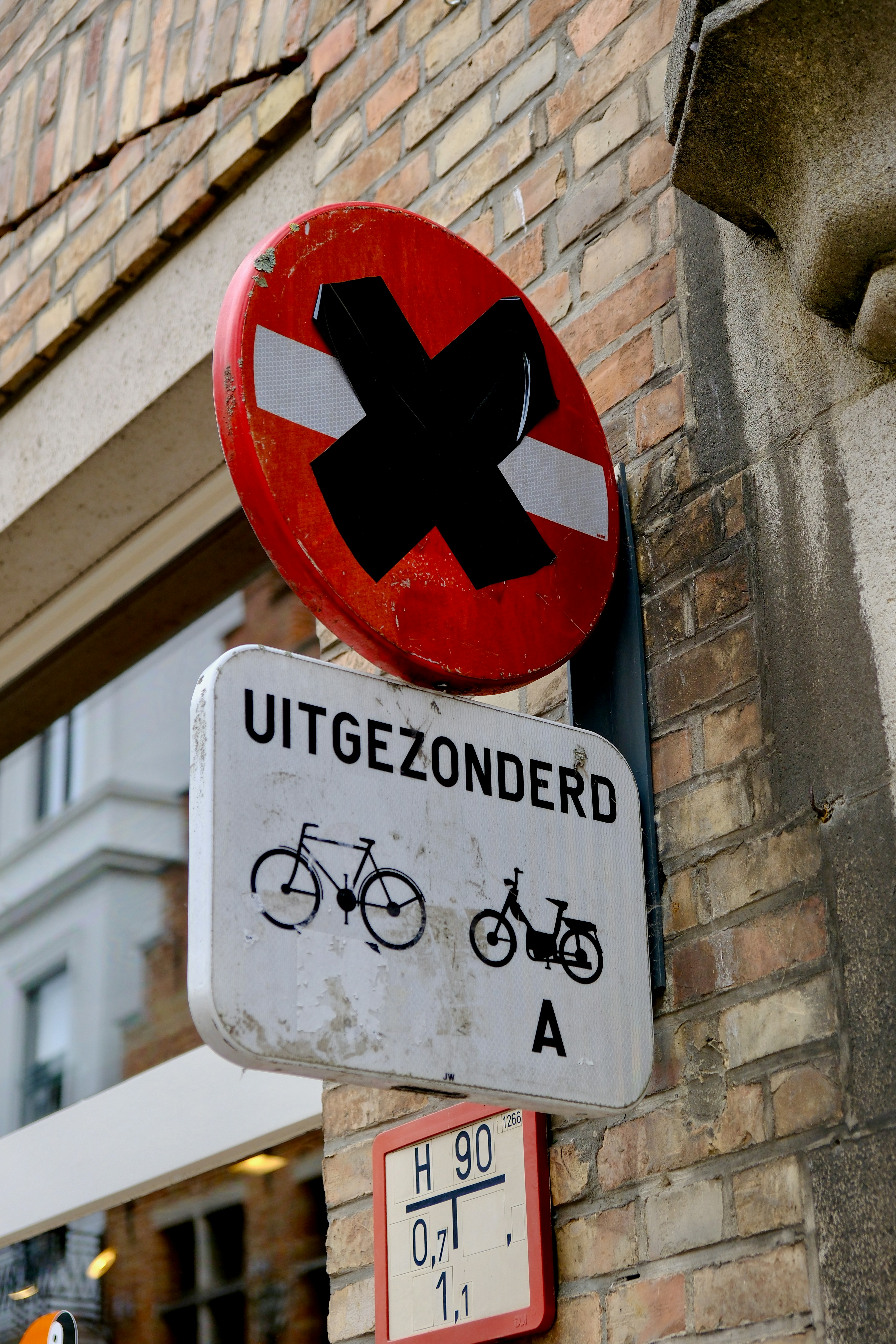Crossroads of City Signage: A Brick and Bicycle Moment