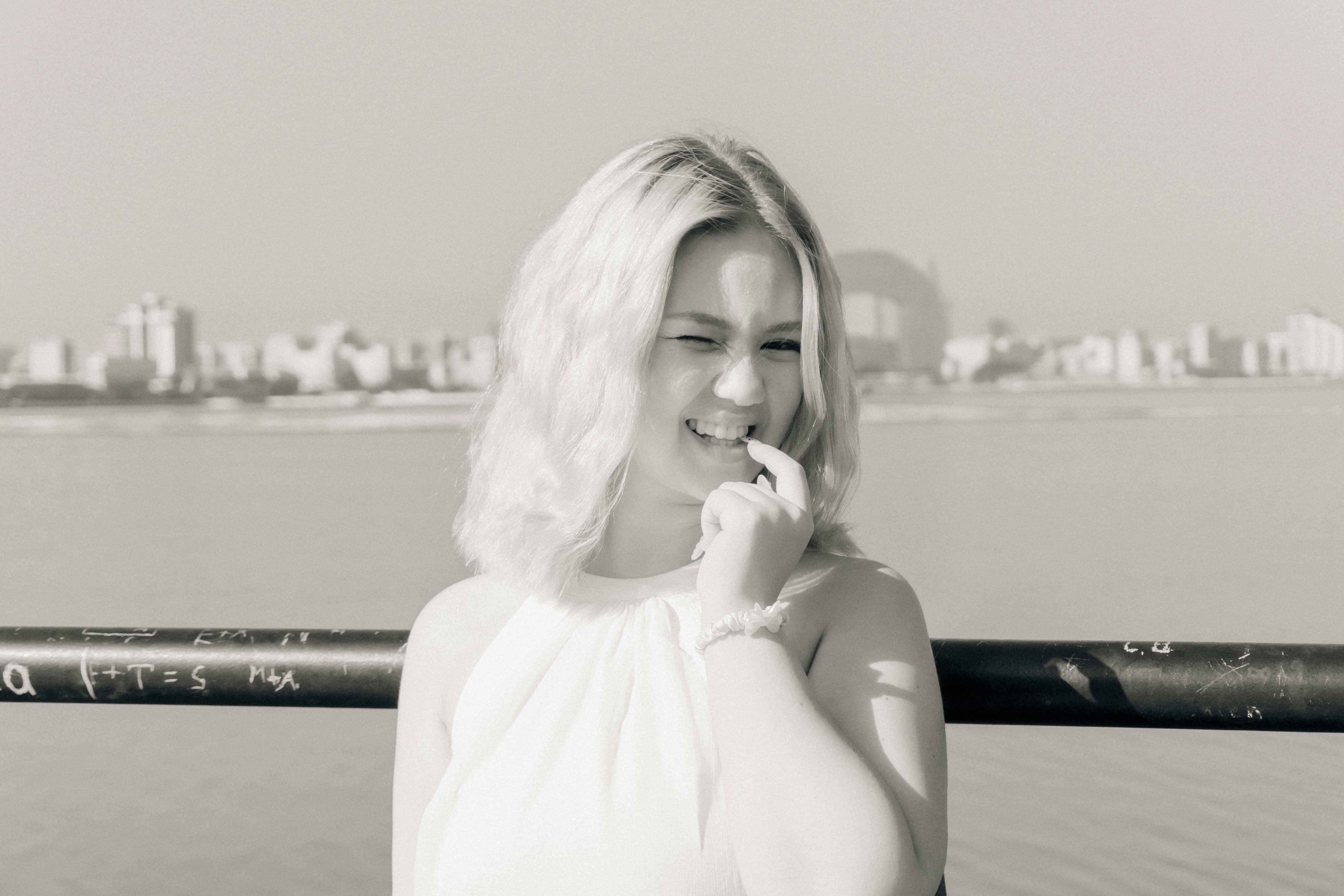 Portrait at the Waterfront: A Soft Smile by the Distant City