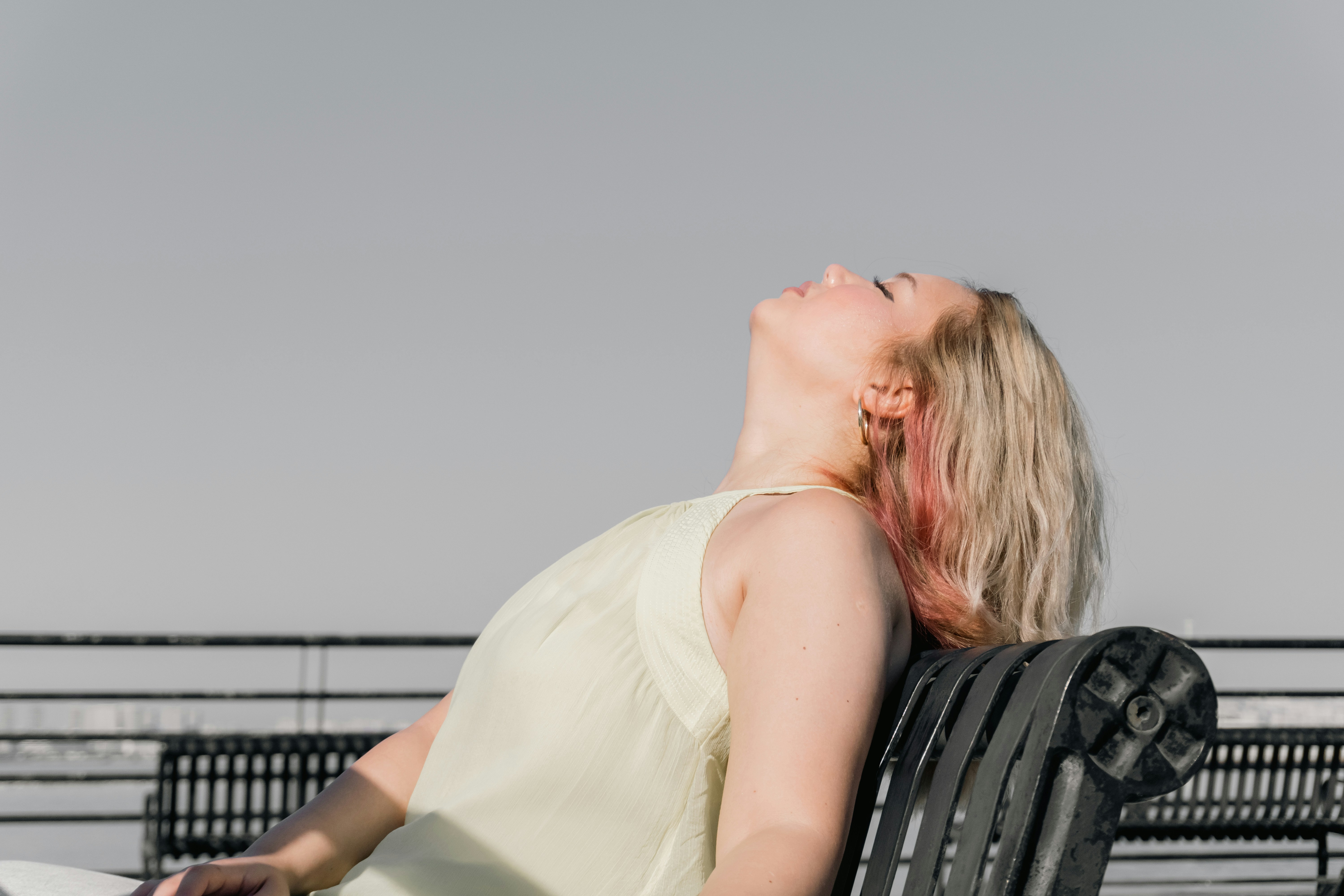 Sunlit Tilt: A Quiet Moment on the Rooftop Bench