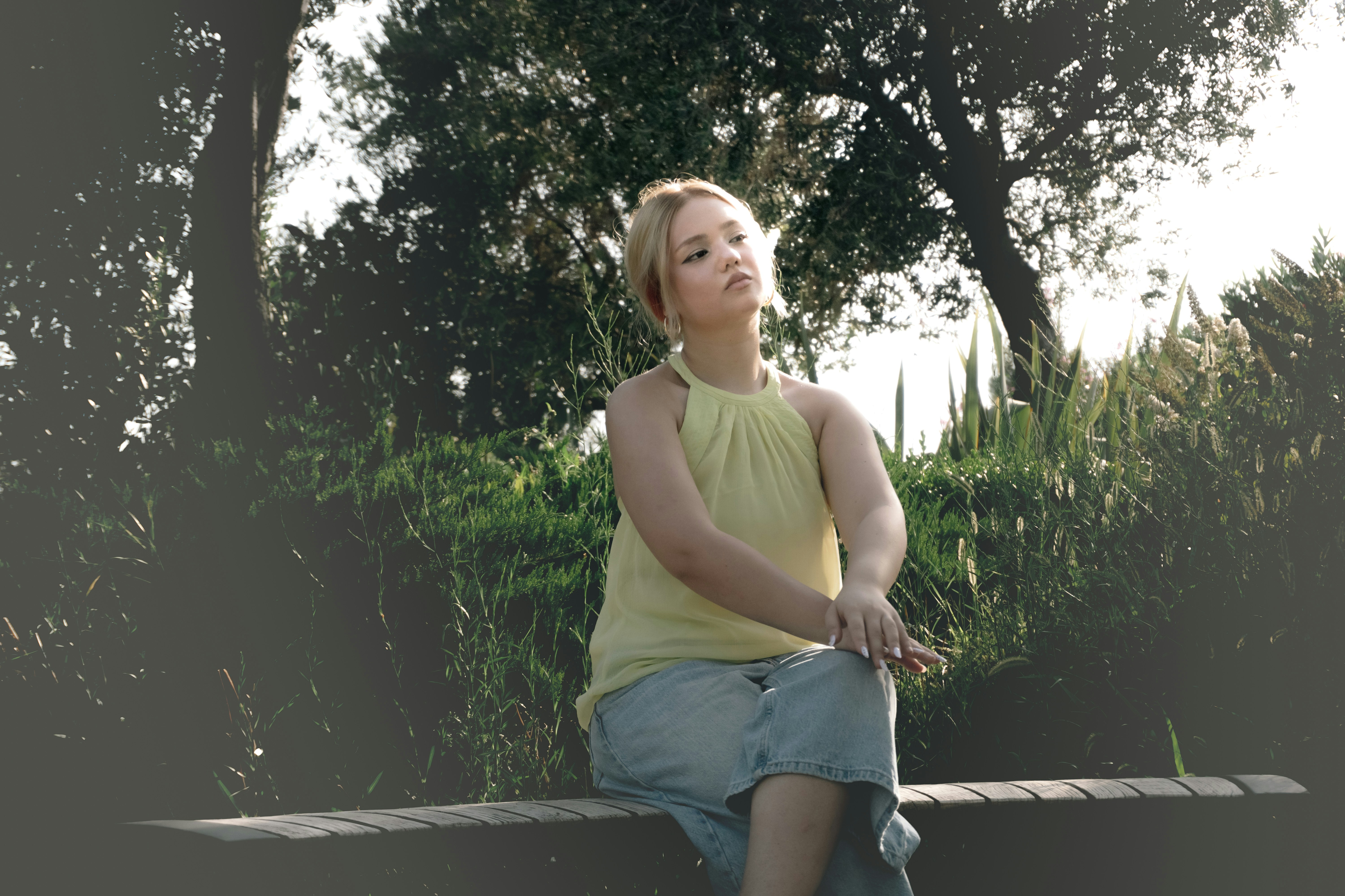 Sunlit Youth: A Quiet Moment on the Park Bench