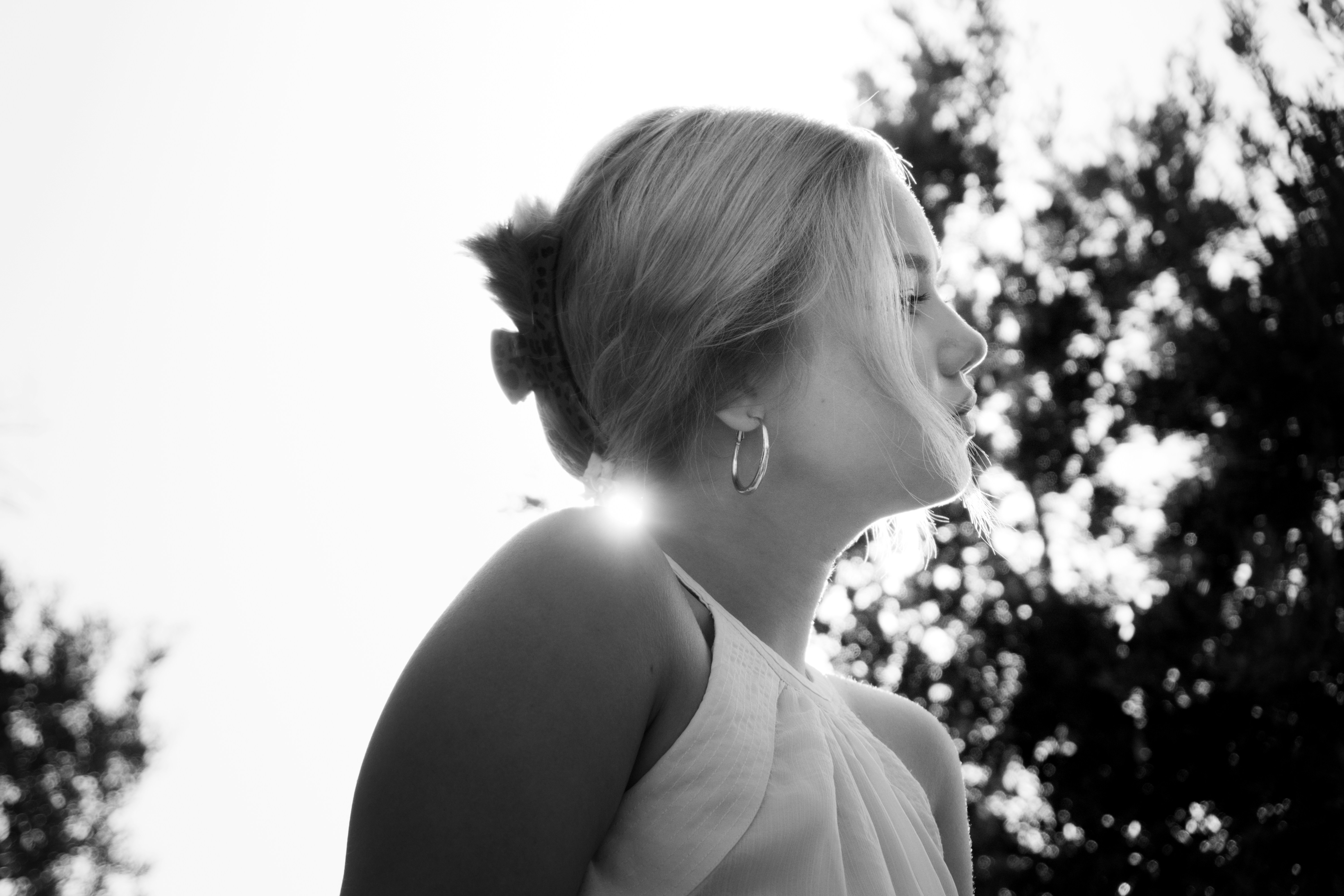 Sunlit Profile: A Woman in Quiet Contemplation