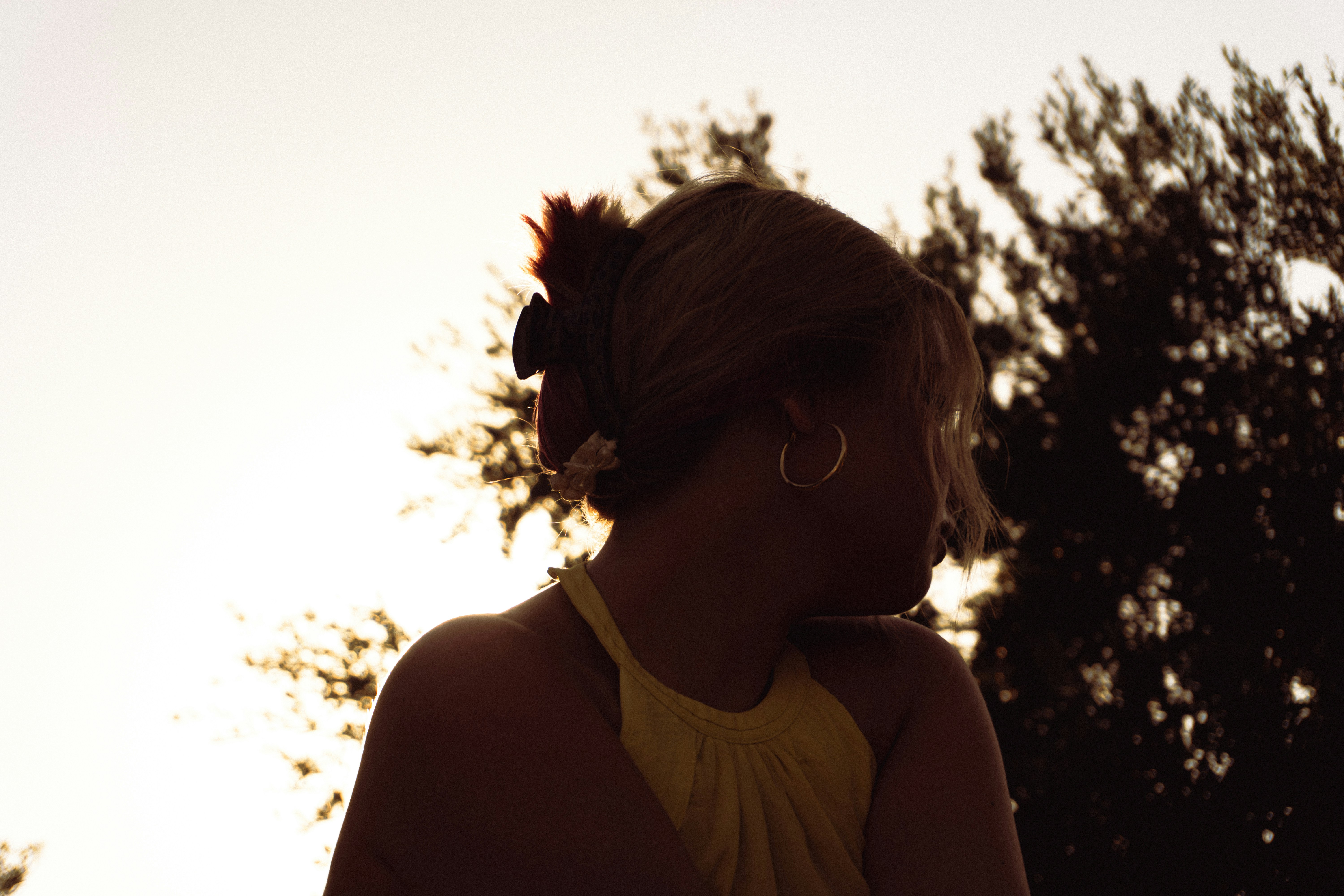 Silhouette in the Sunset: Quiet Grace of a Woman in Yellow