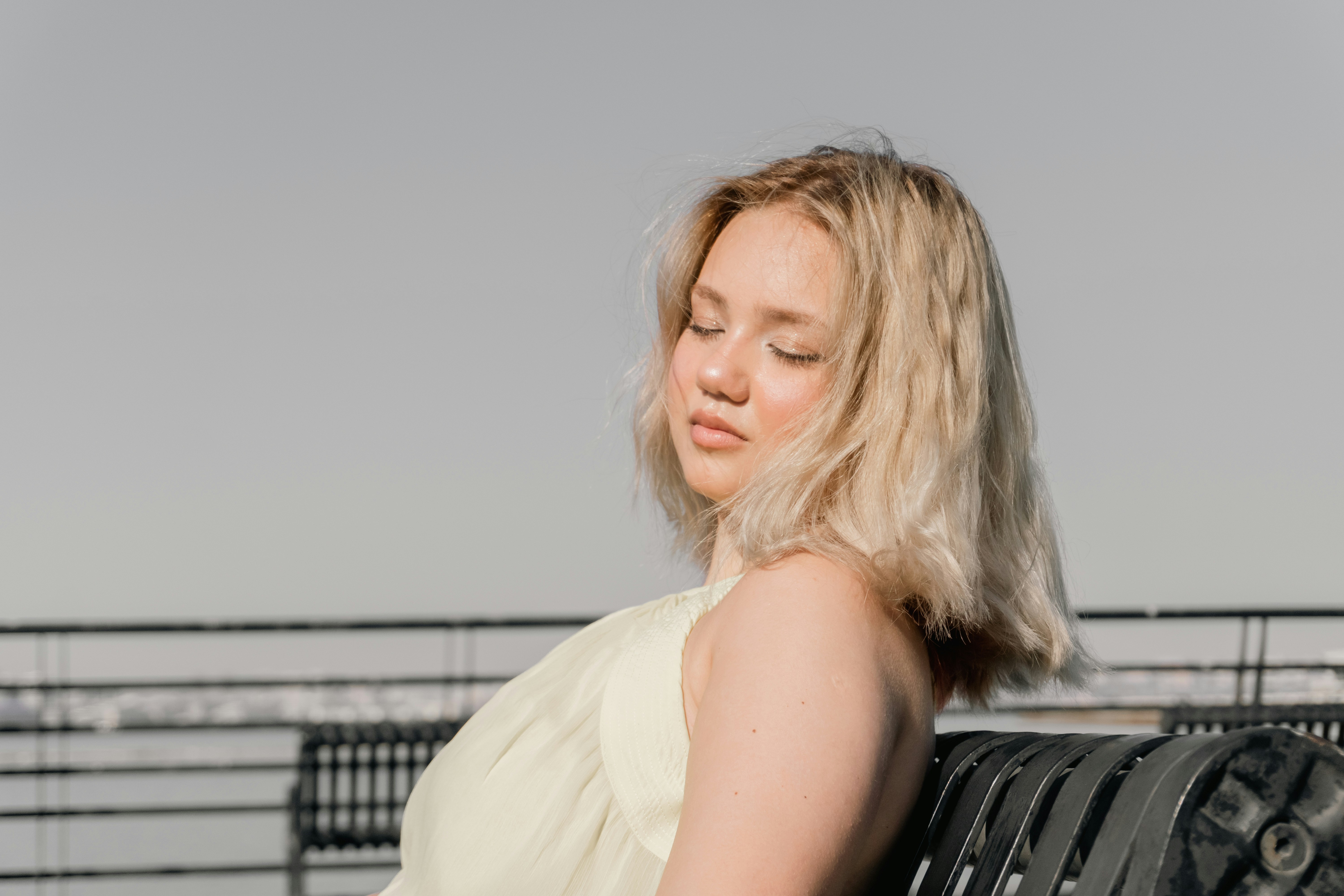 Soft Light on the Edge: Portrait on a Quiet Balcony