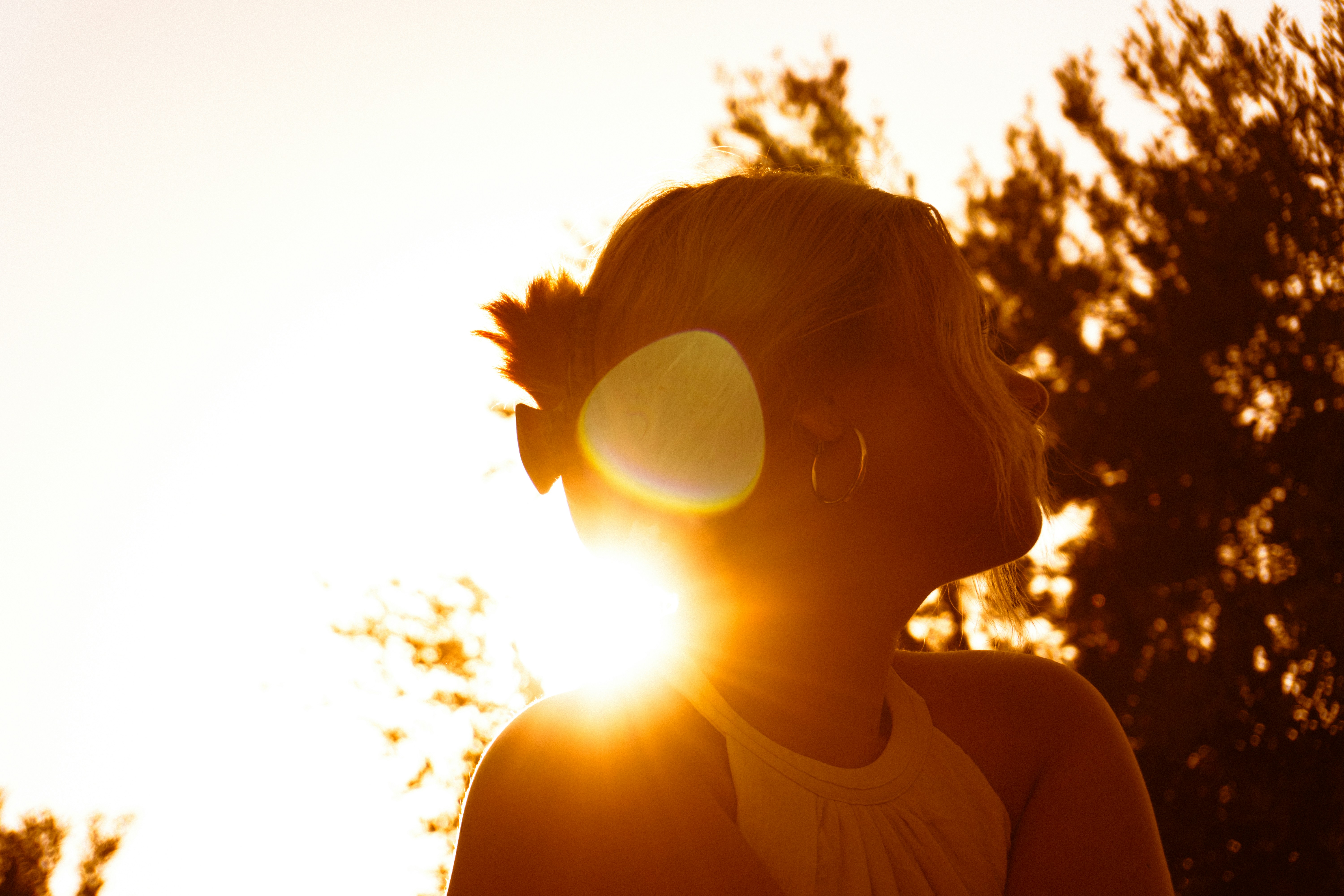 Backlit Whisper: A Sun-Kissed Silhouette of a Woman