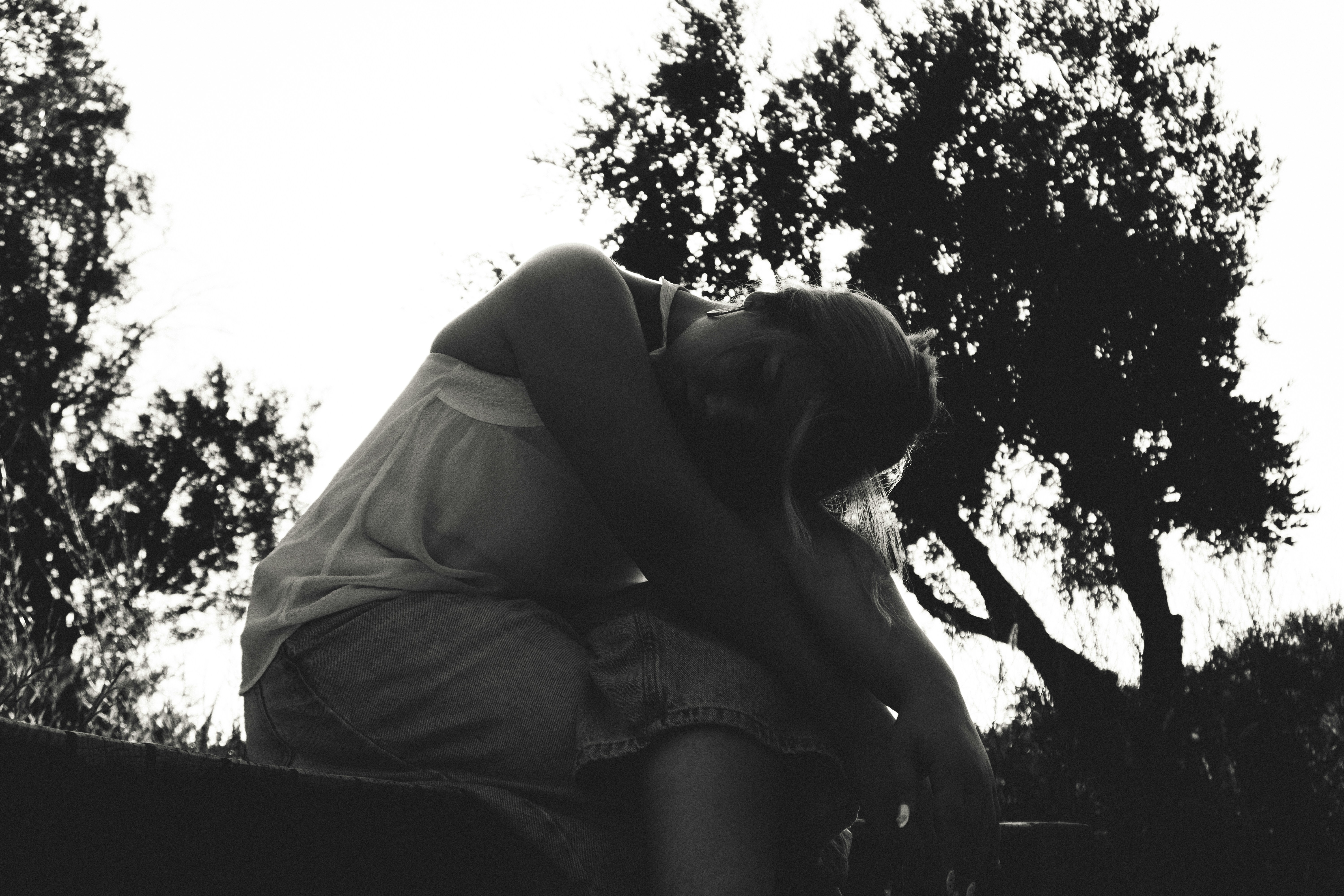 Quiet Union: A Moment of Embrace Beneath Shadowed Branches